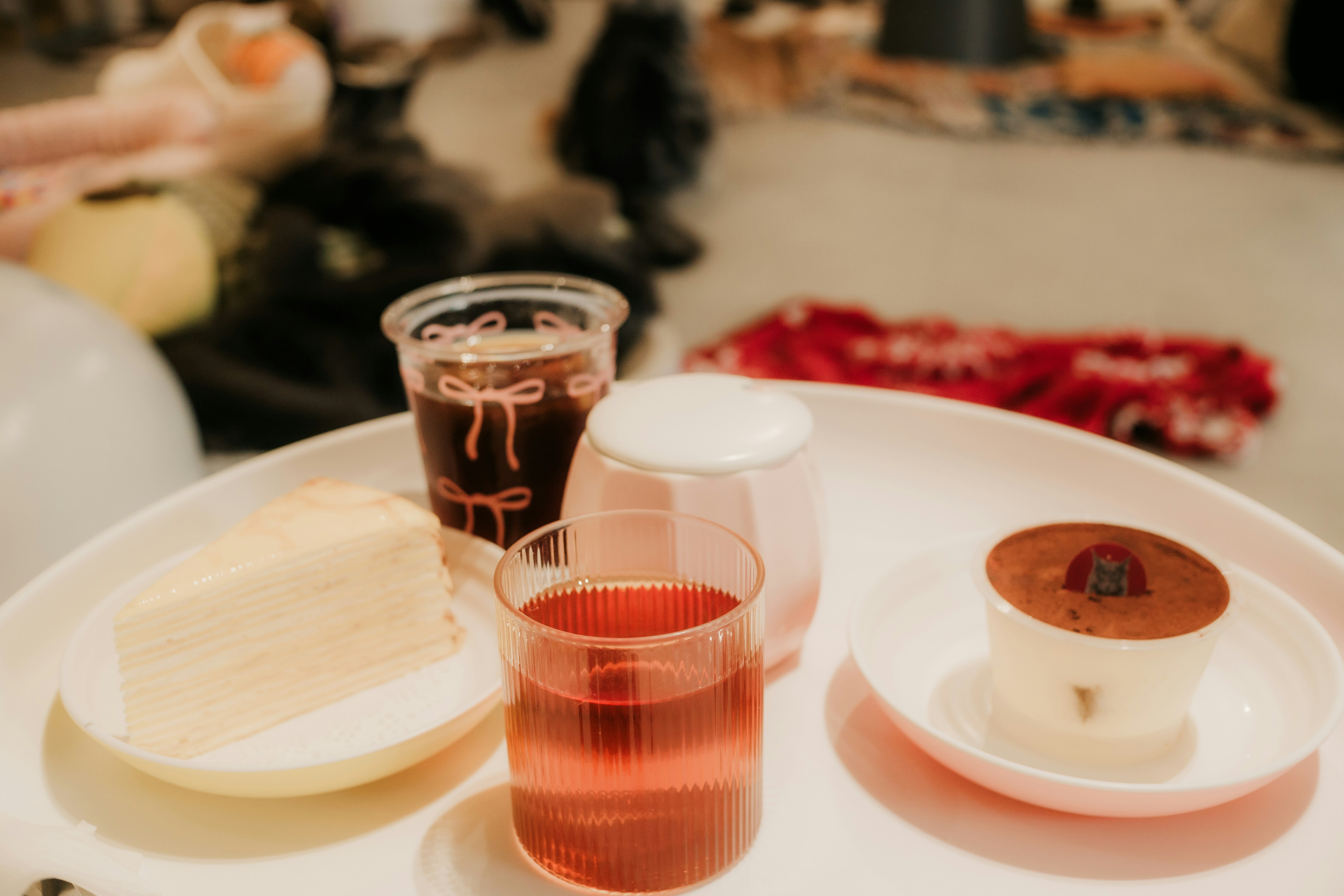 A Quiet Tea Moment: Assorted Desserts and Drinks on a Round Tray