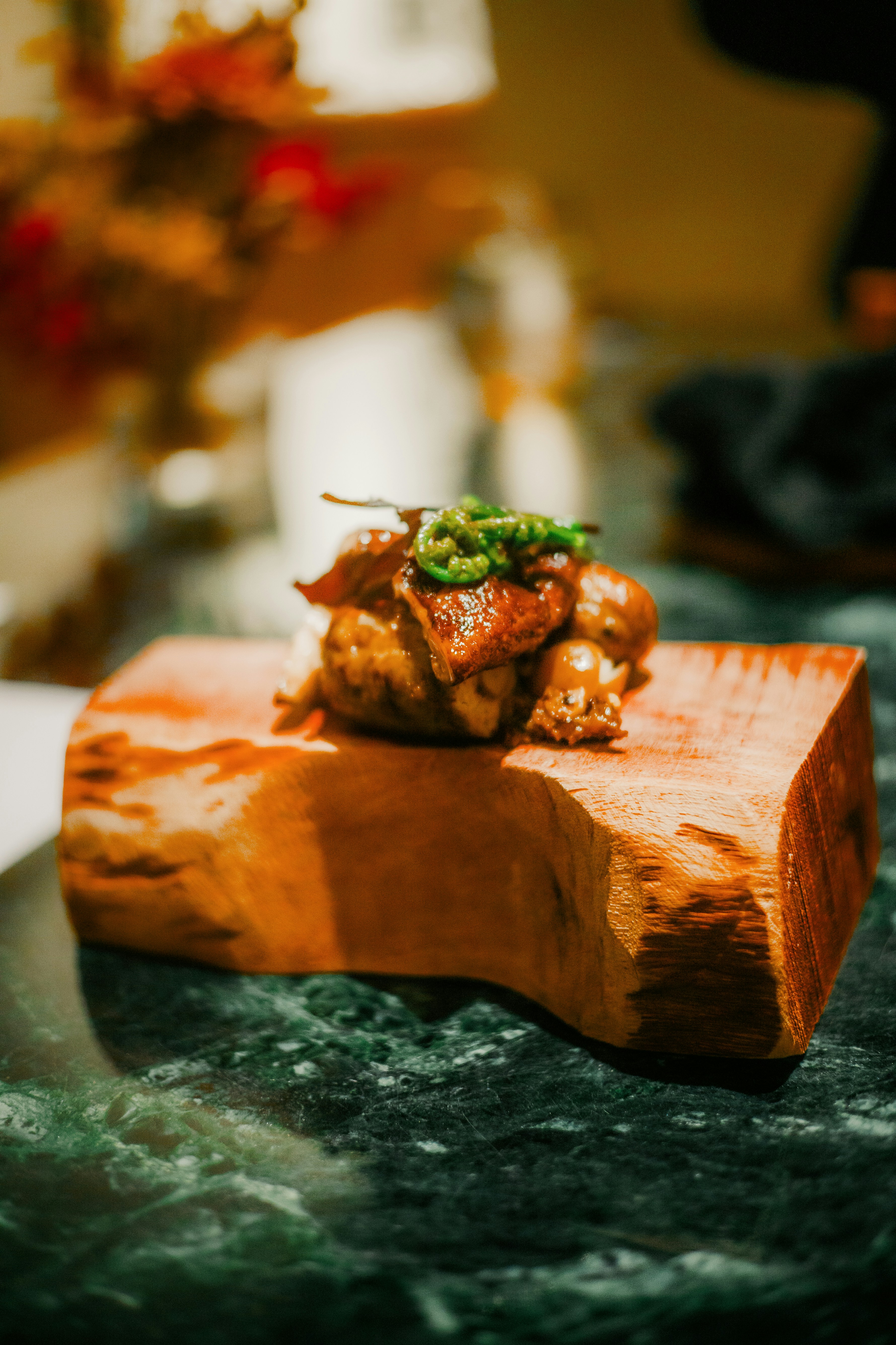 Wooden pedestal bites: a savory morsel crowned with greens