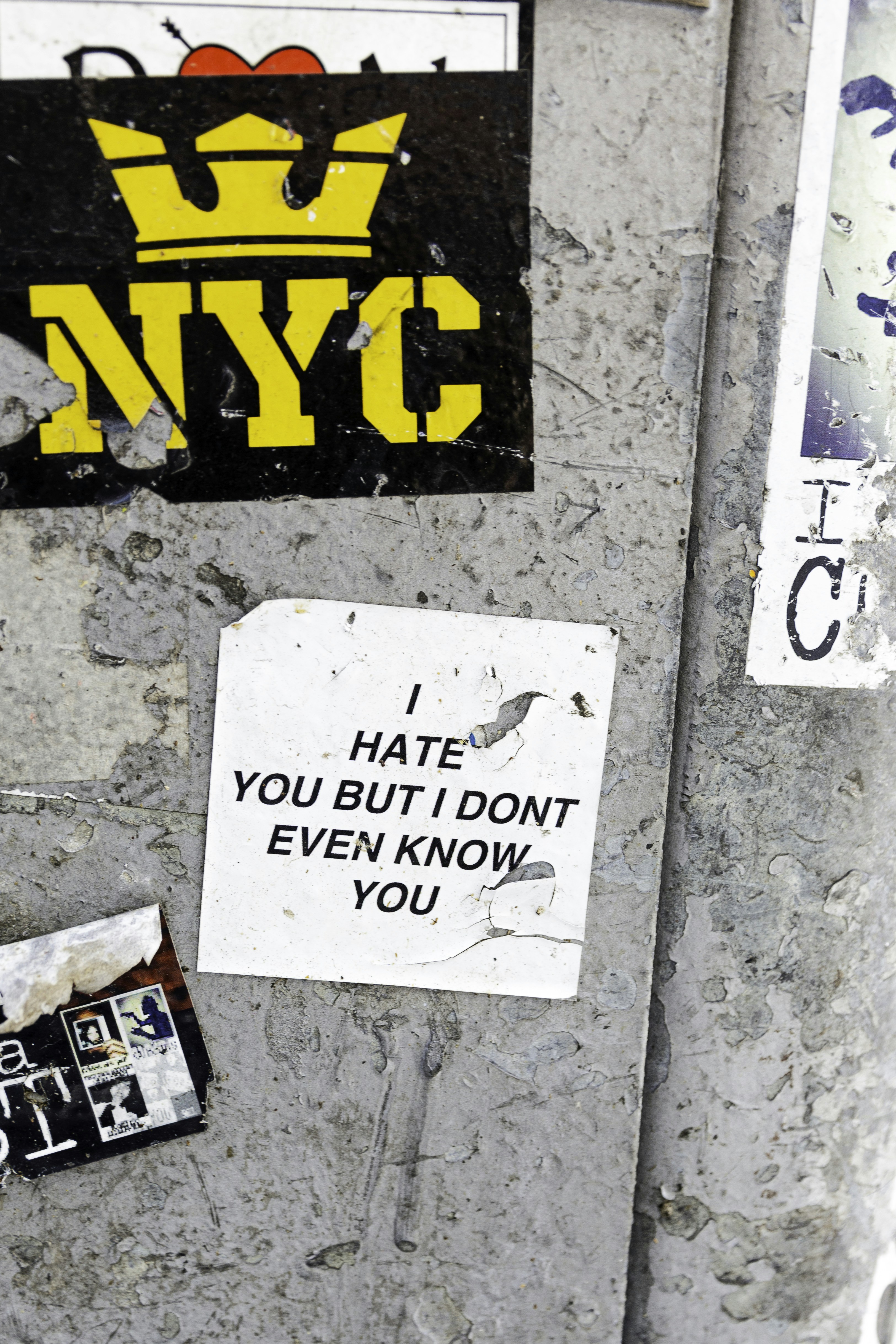 Stickered Wall in Neon City: I Hate You But I Don't Even Know You