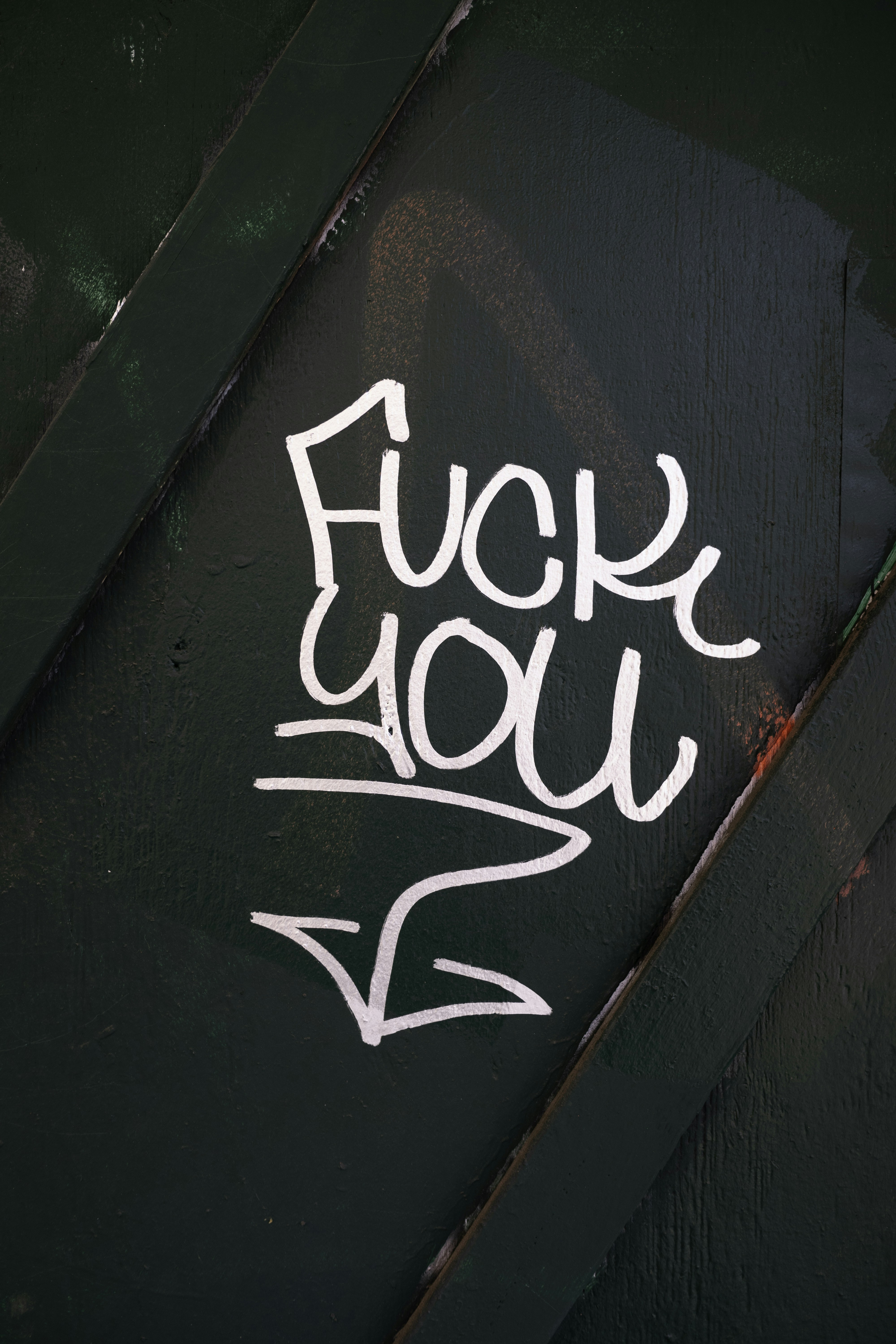 White Graffiti Expression on Dark Green Panels
