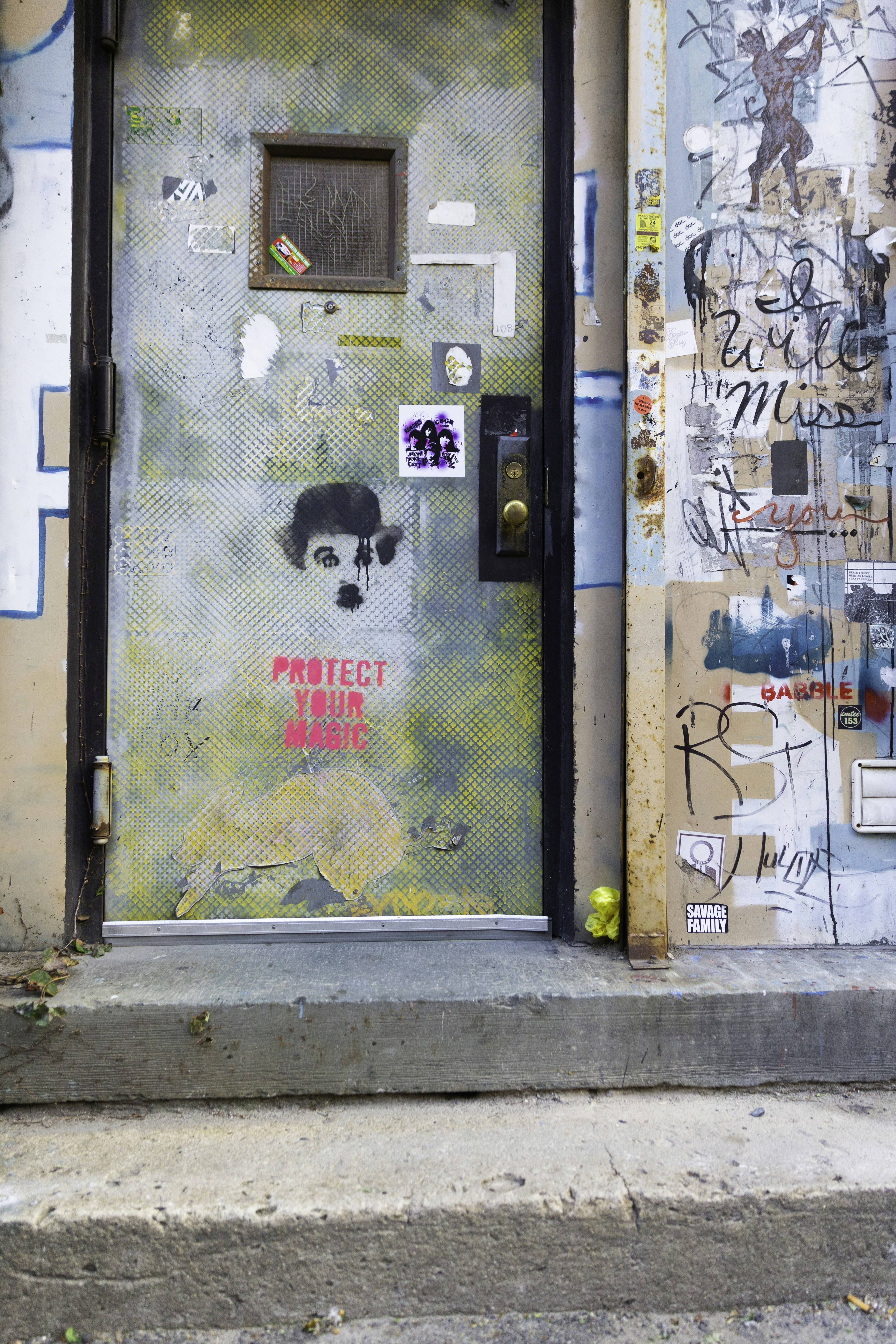 Doorway of Street Art: Graffiti, Stamps, and a Neon Message