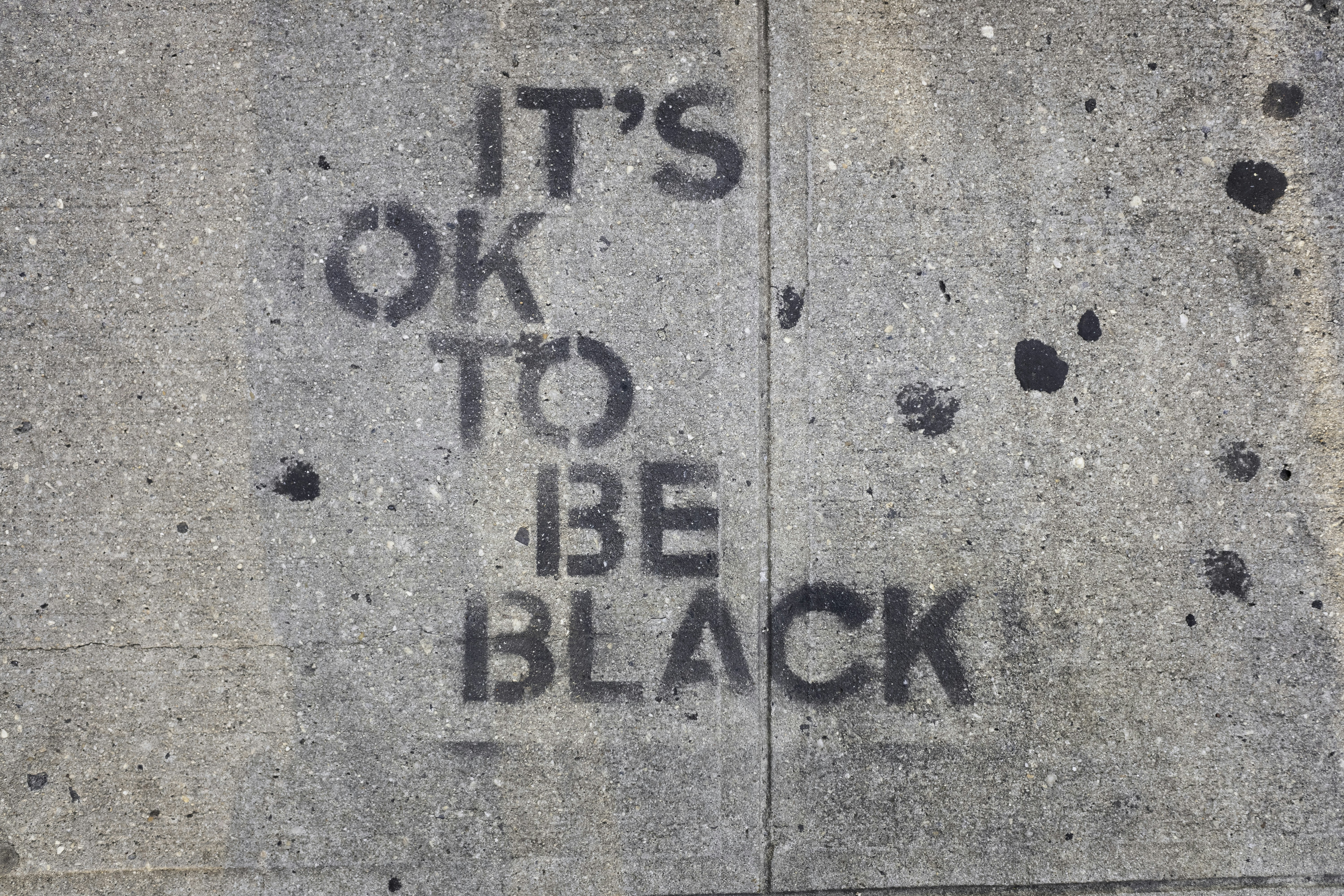 Stencil Graffiti: It’s OK to Be Black on a Weathered Sidewalk
