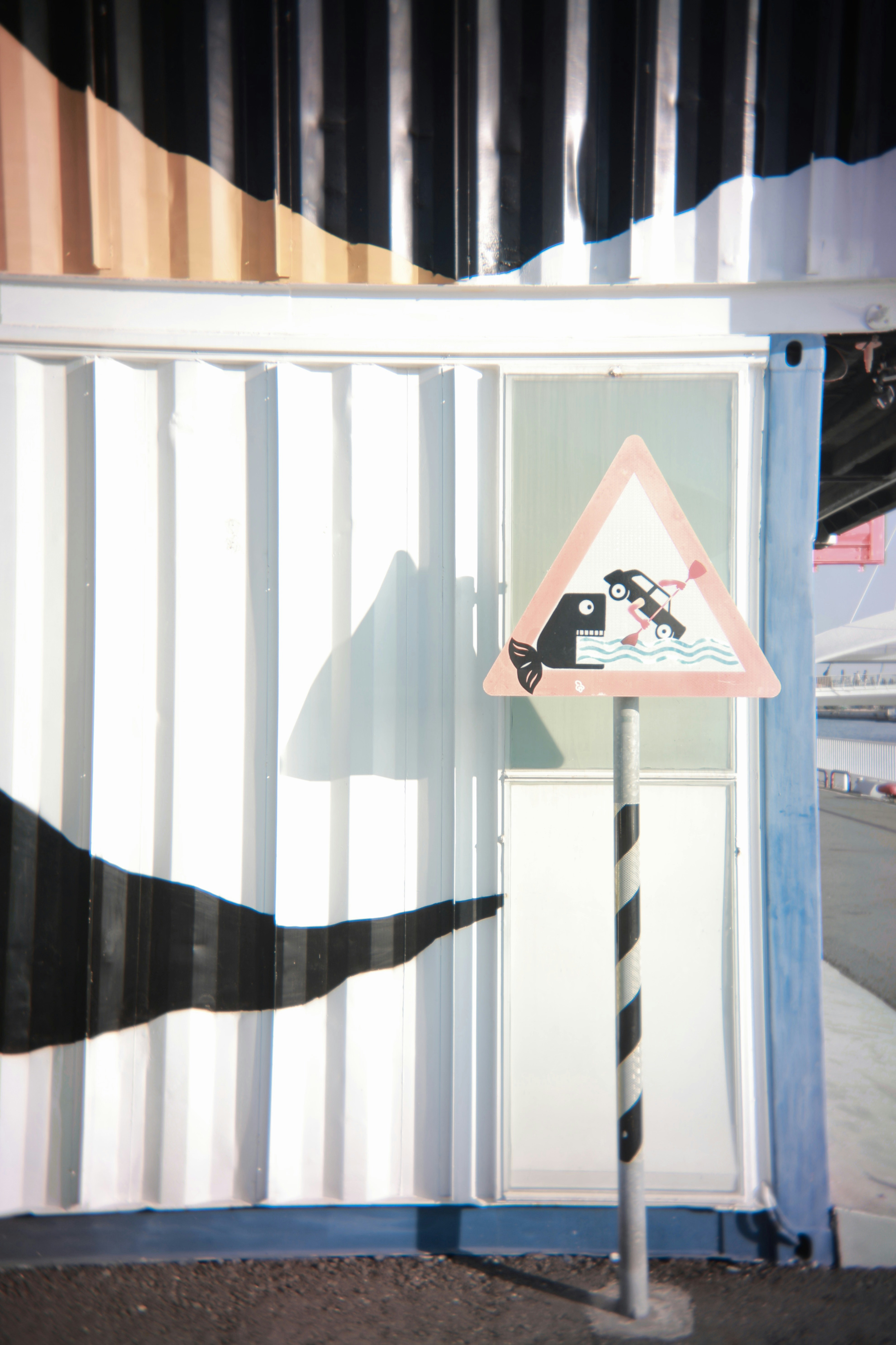 Shadowed Signage by a Corrugated Wall