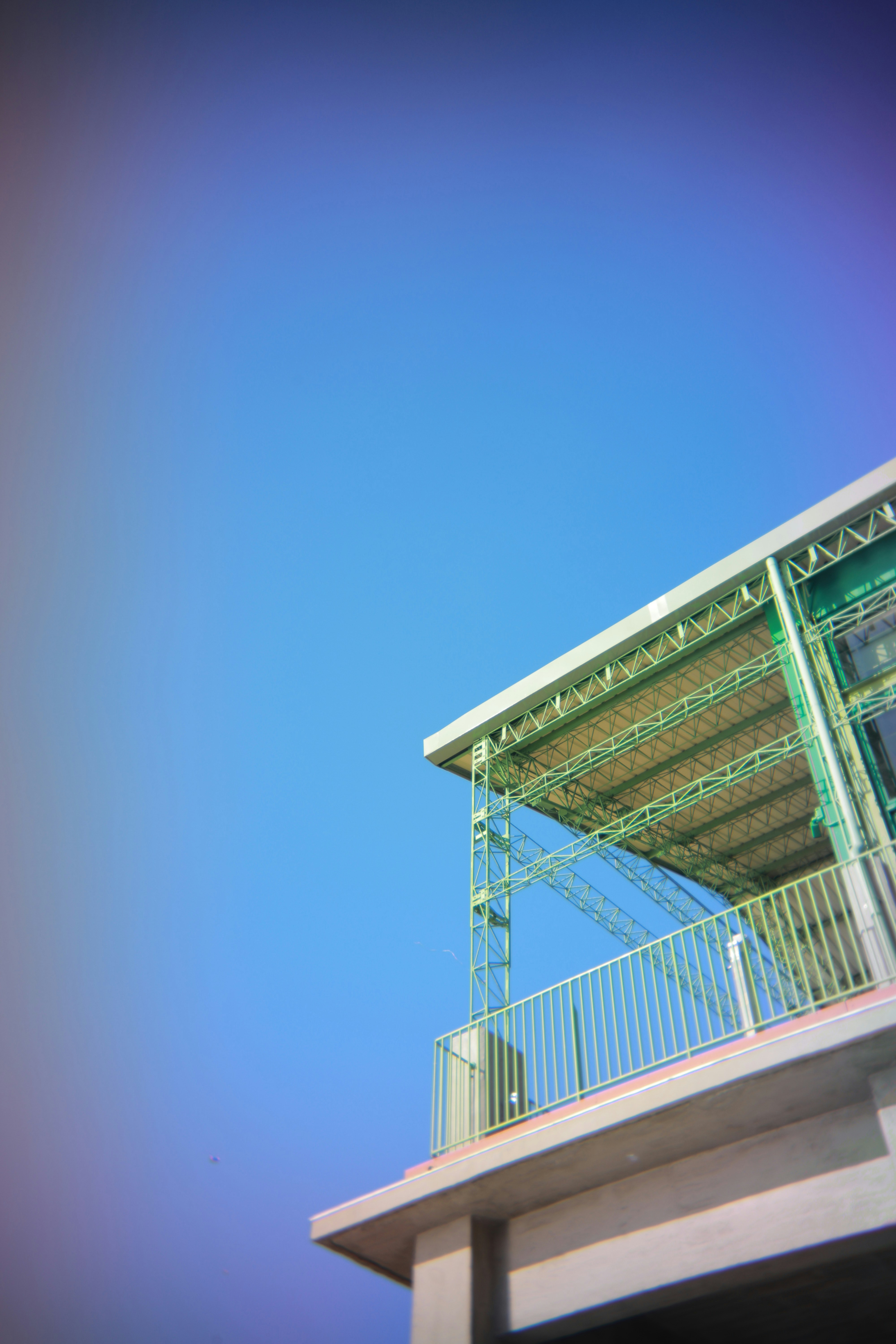Architectural Edge: A Modern Balcony Reaching into a Clear Sky