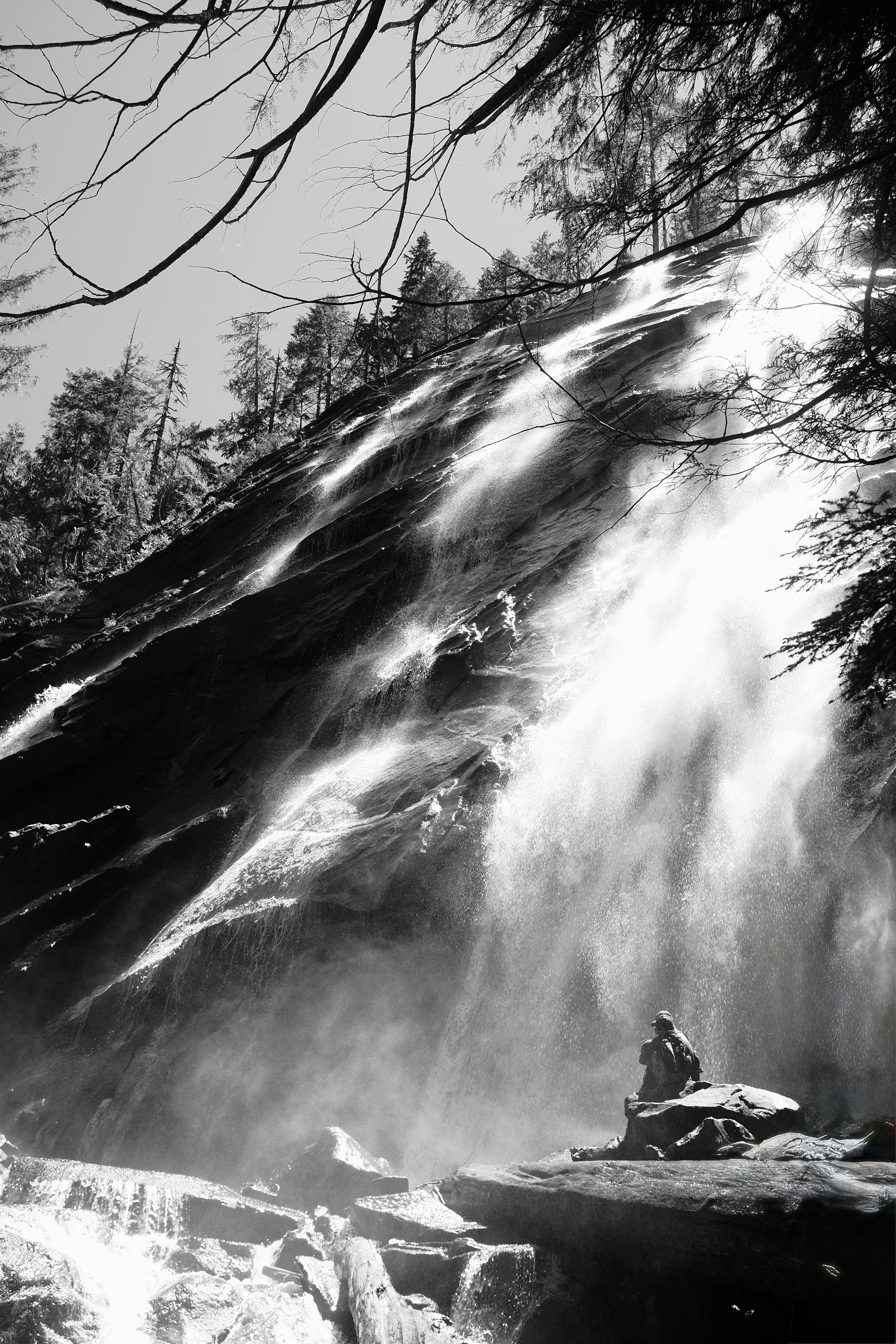 Rushing Silence: A Lone Figure Beneath a Cascade of Light