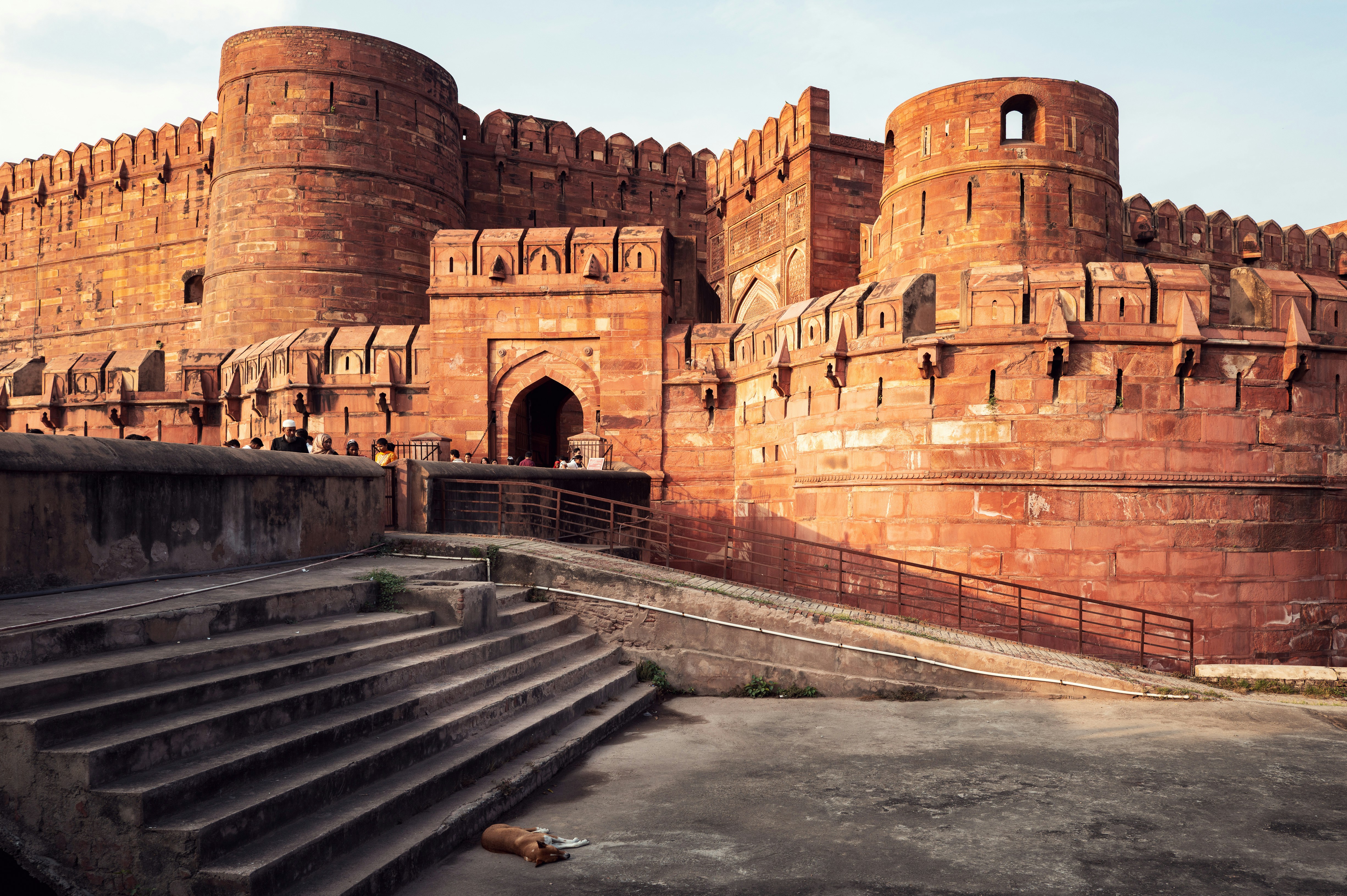 Gateway to the Red Fortress: Sunlit Ramparts Framing the Entrance