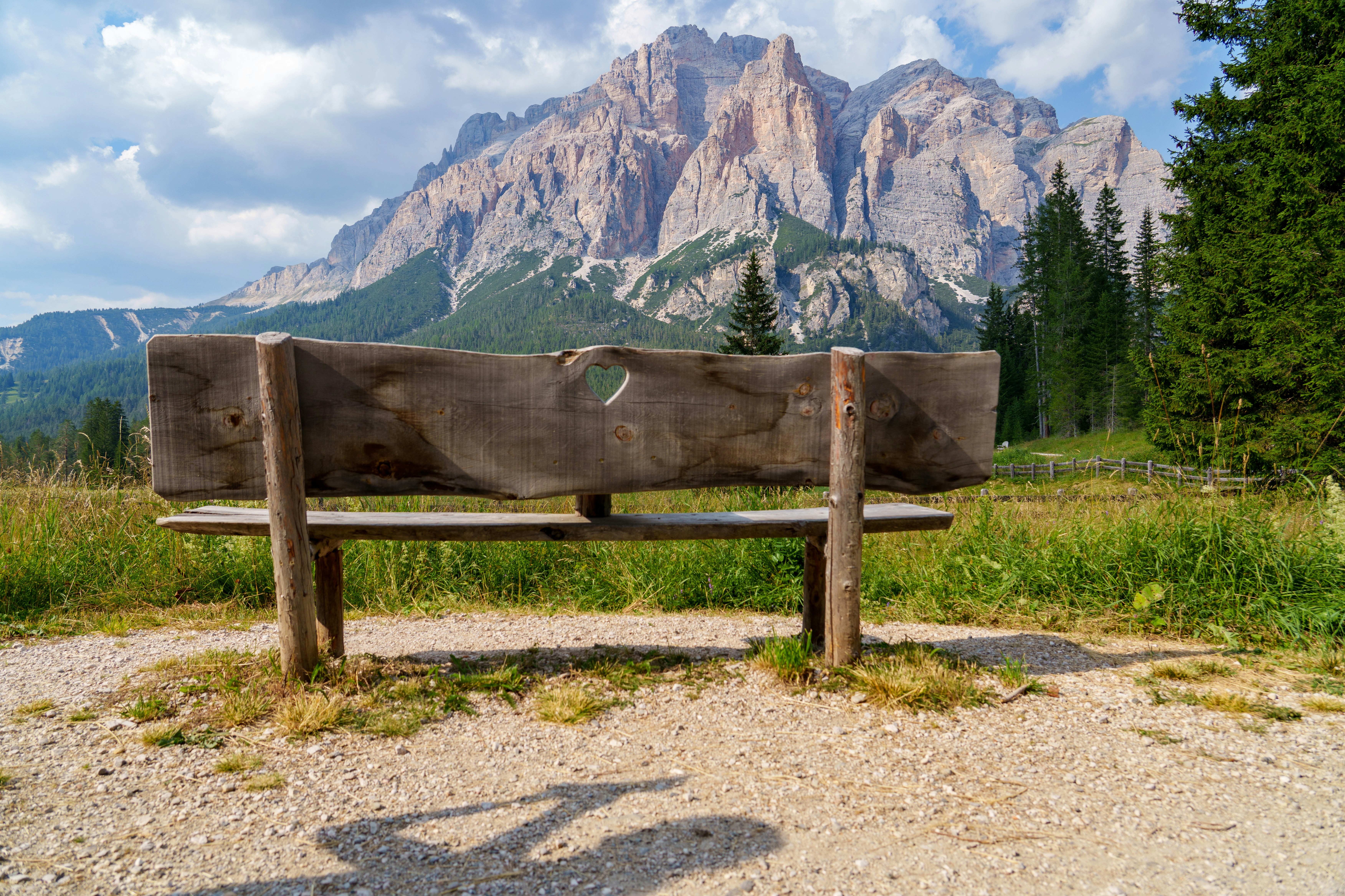 Weathered bench with alpine backdrop