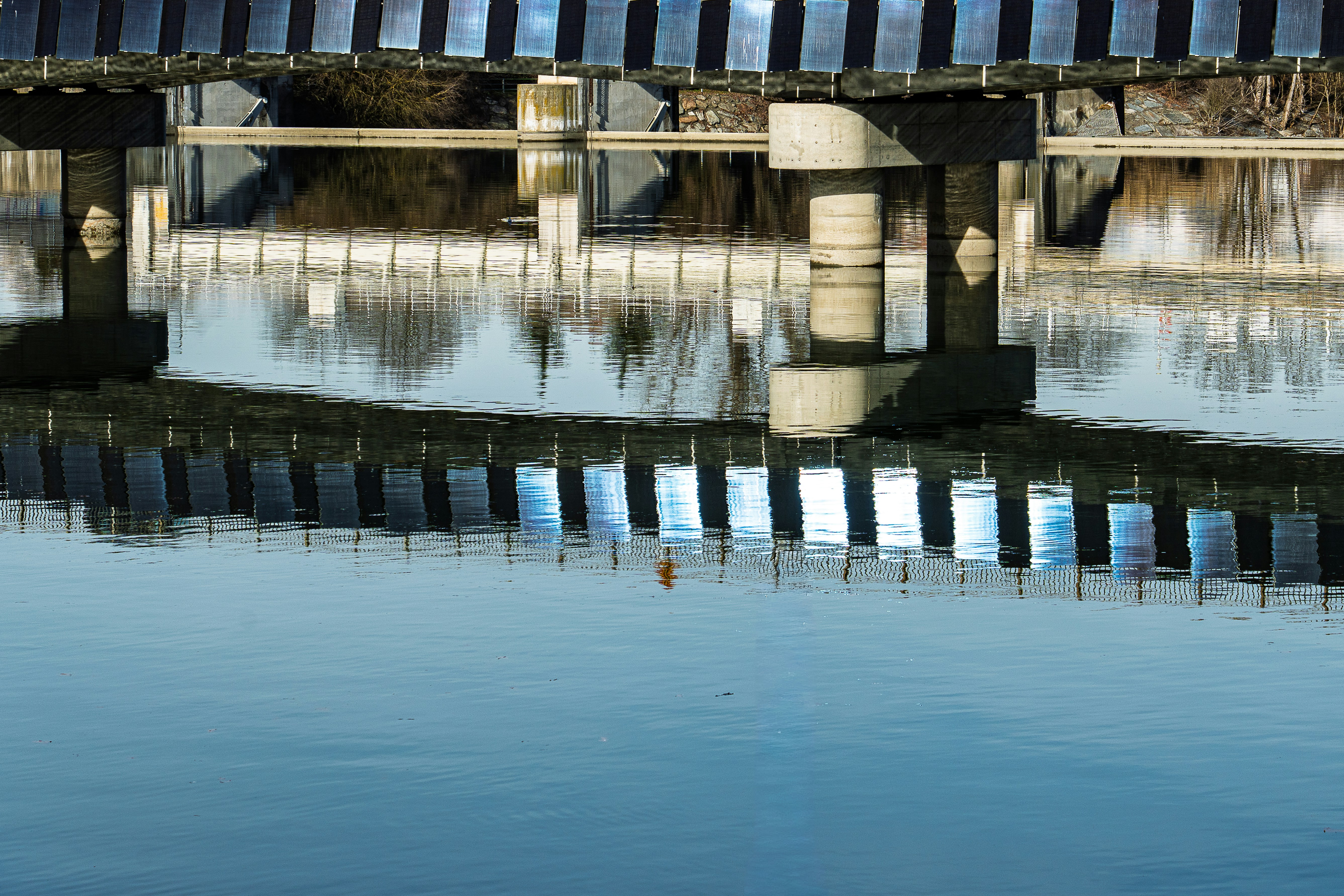 Bridge Reflections: Calm Water and Repeating Arches