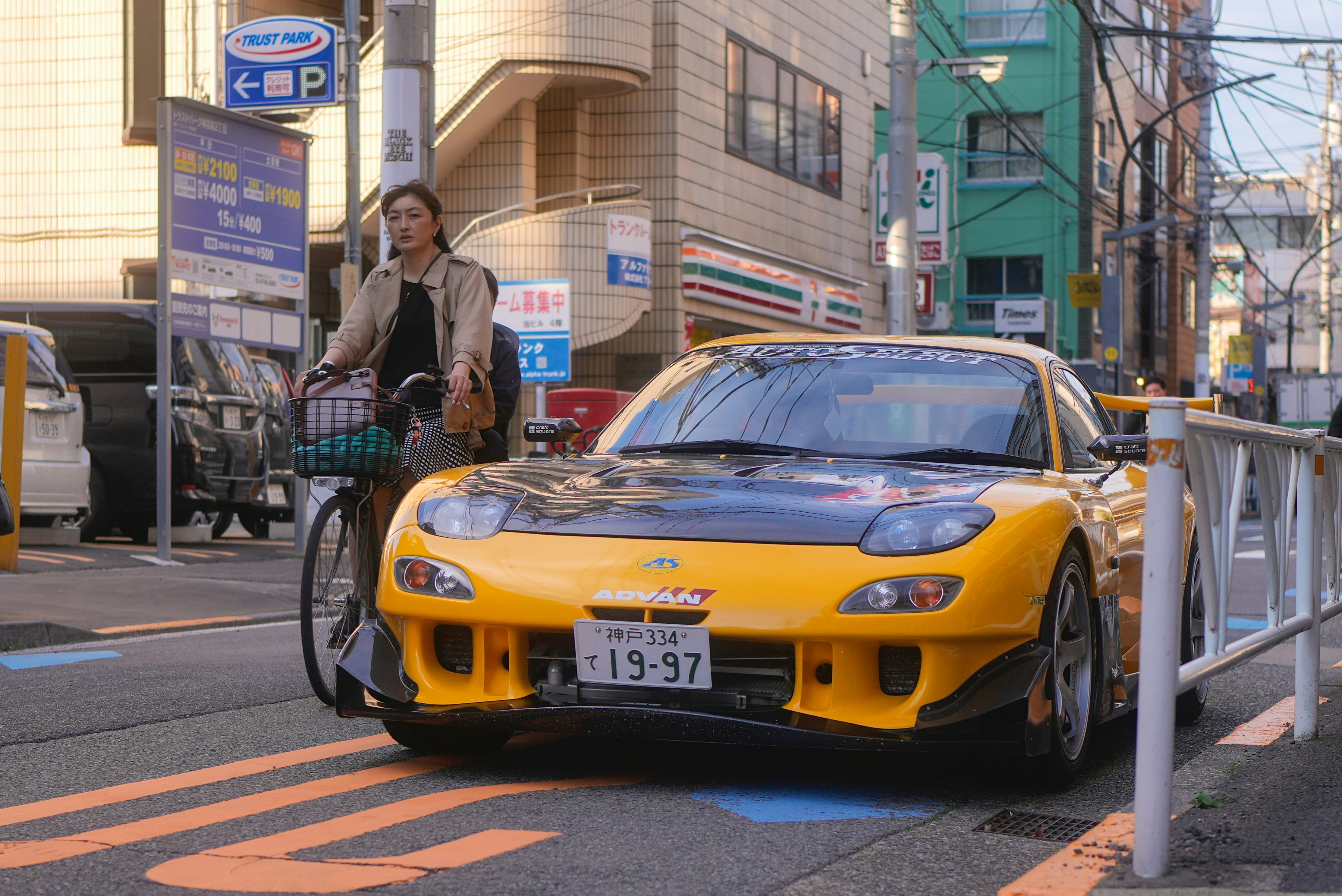 Yellow sports car anchors a busy urban street scene