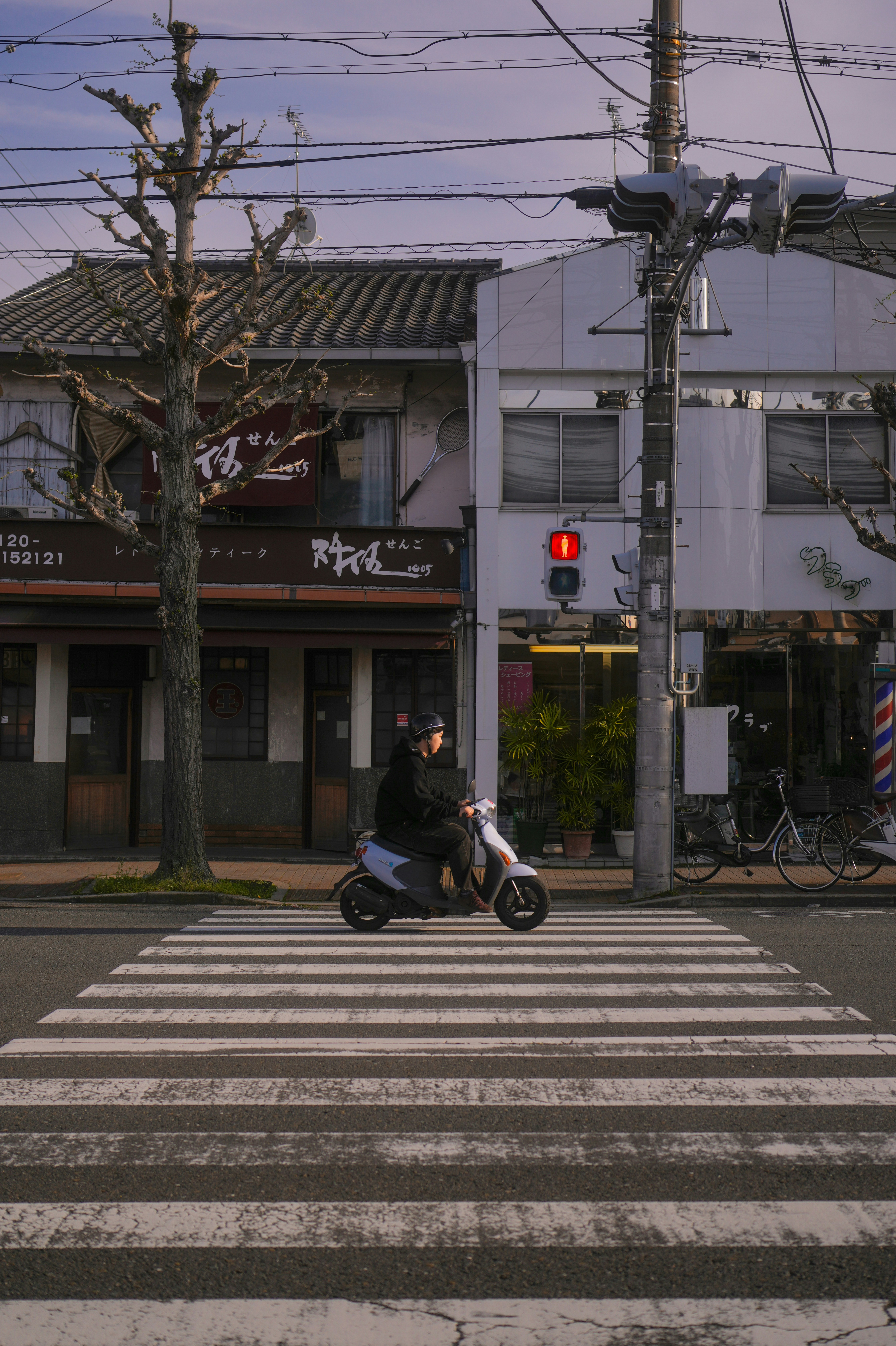 Courier of the Crosswalk: A Scooter and Street Scene