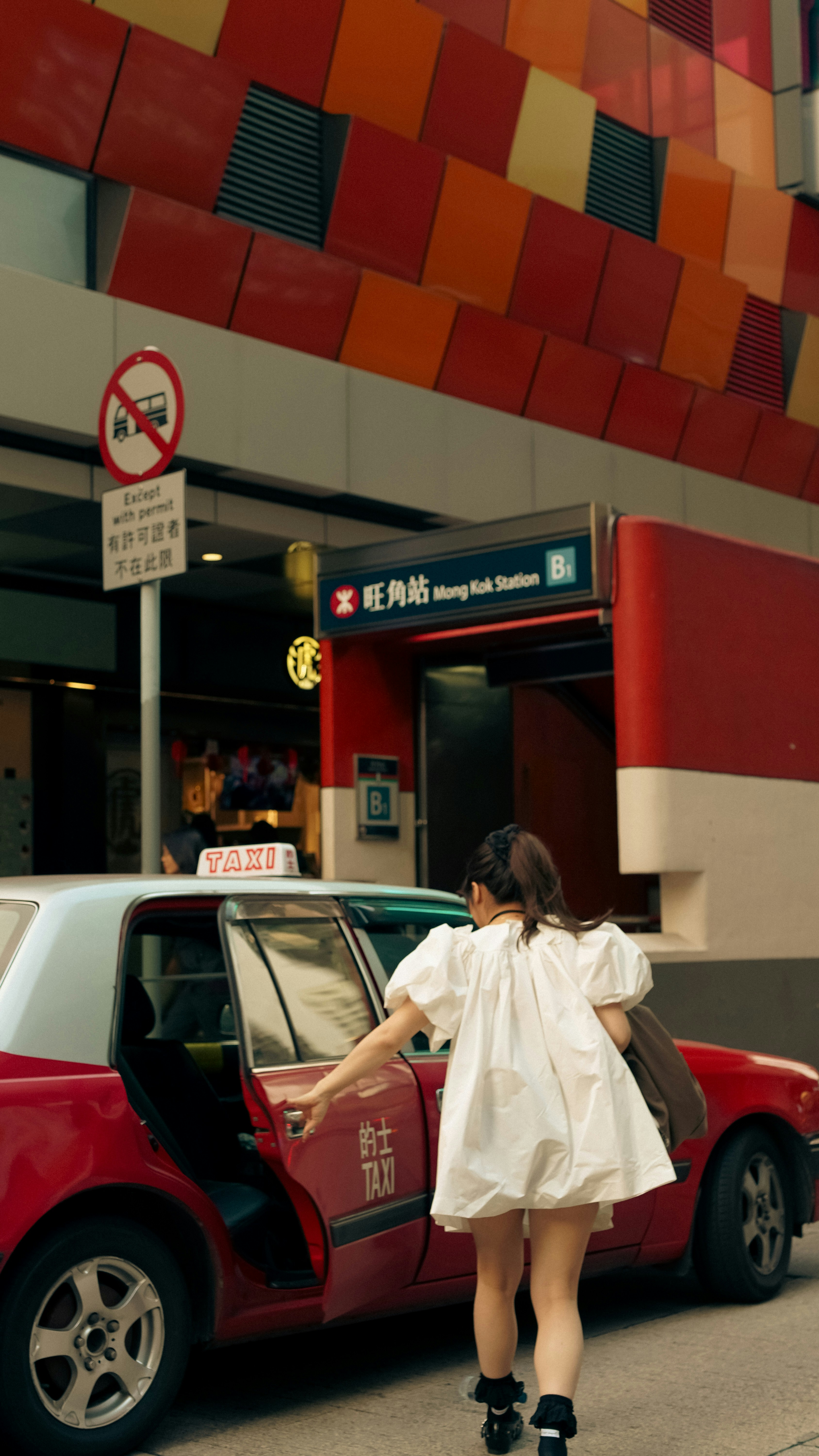 Taxi Stand at Kong Kong Station: A Girl Steps into a Red Taxi