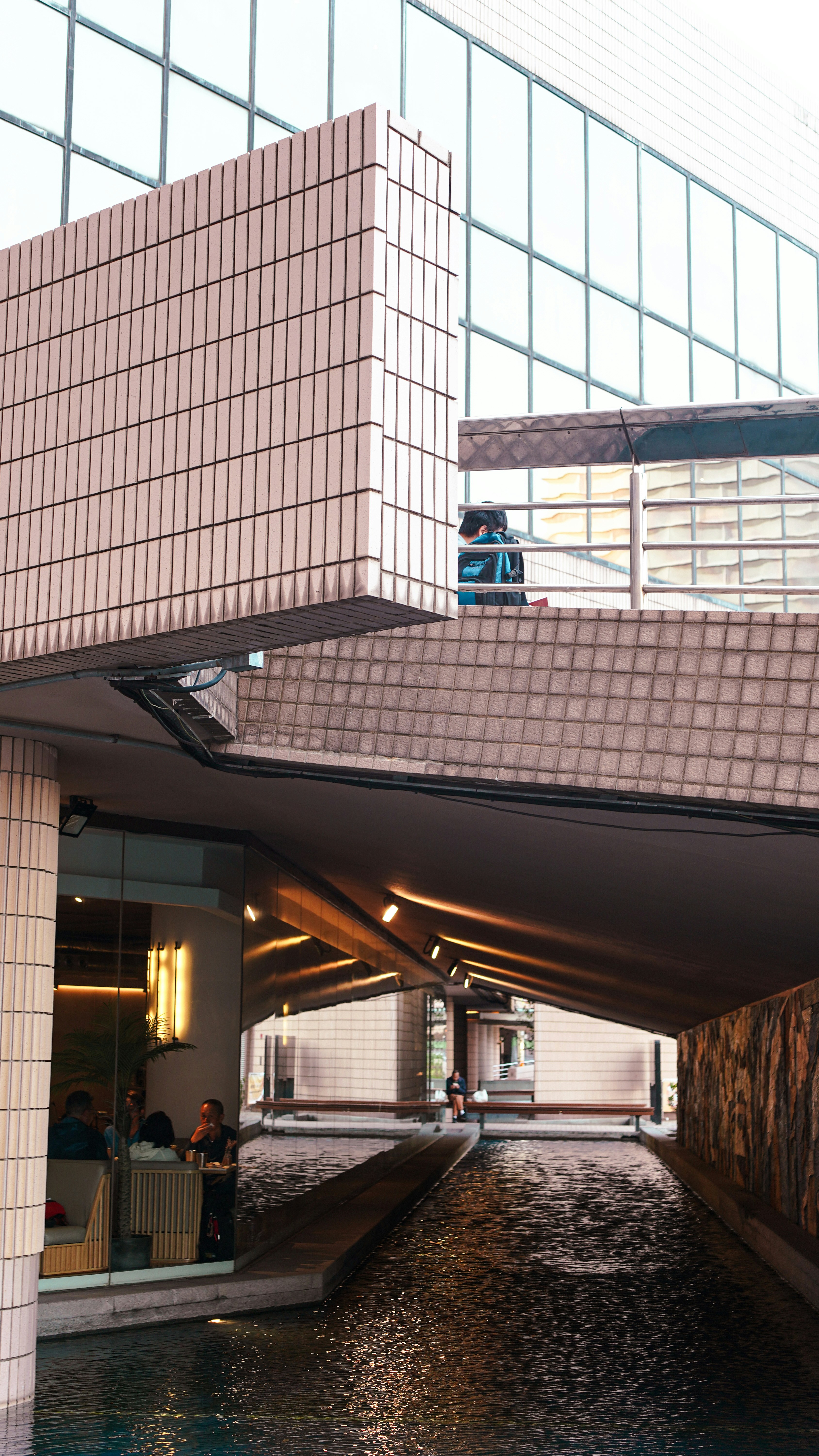 Urban Channel: Lighted Corridor Beneath Glass Facades