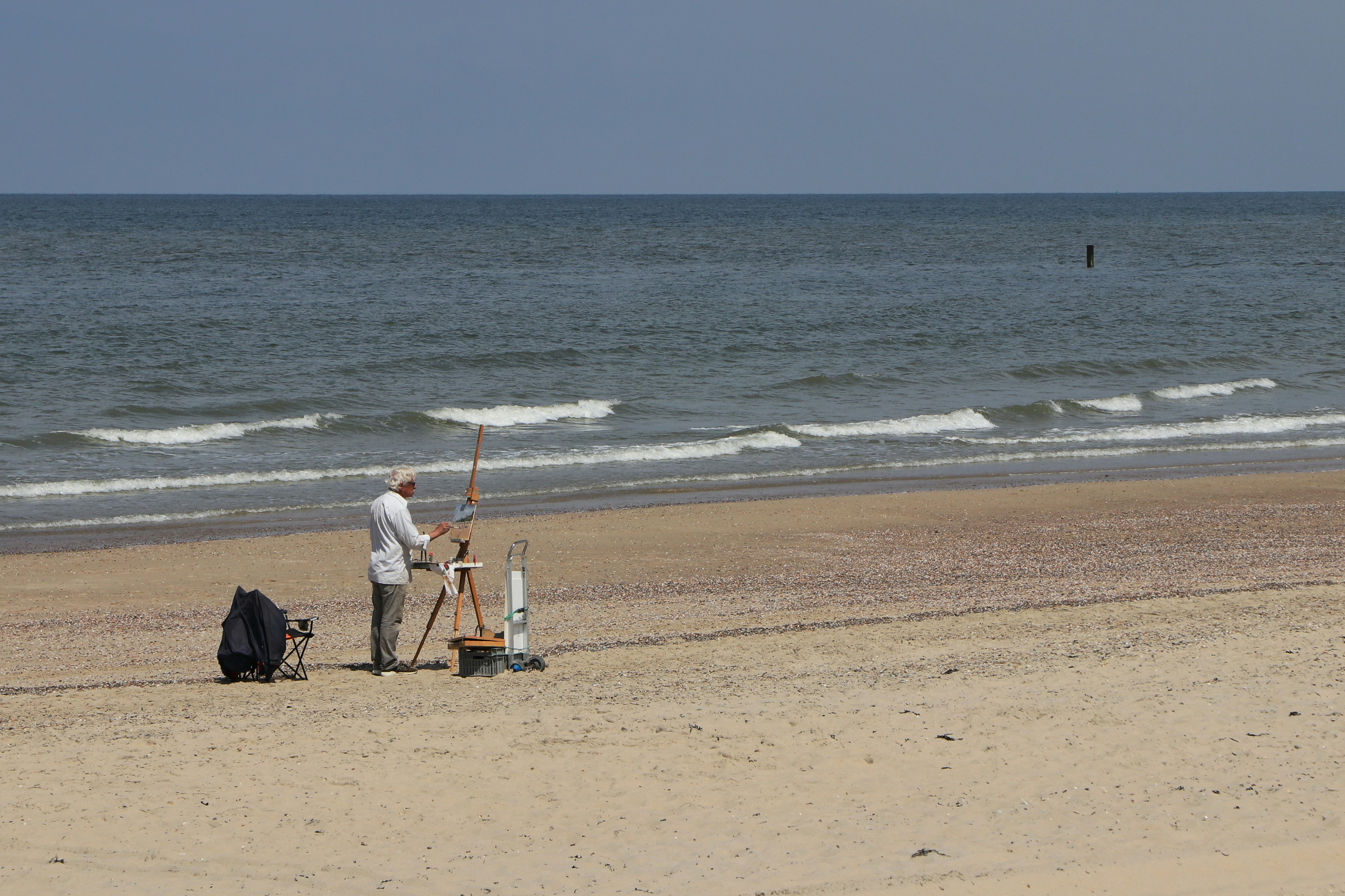 Sea Breeze Studio: A Painter at Dune-Edge on a Quiet Beach