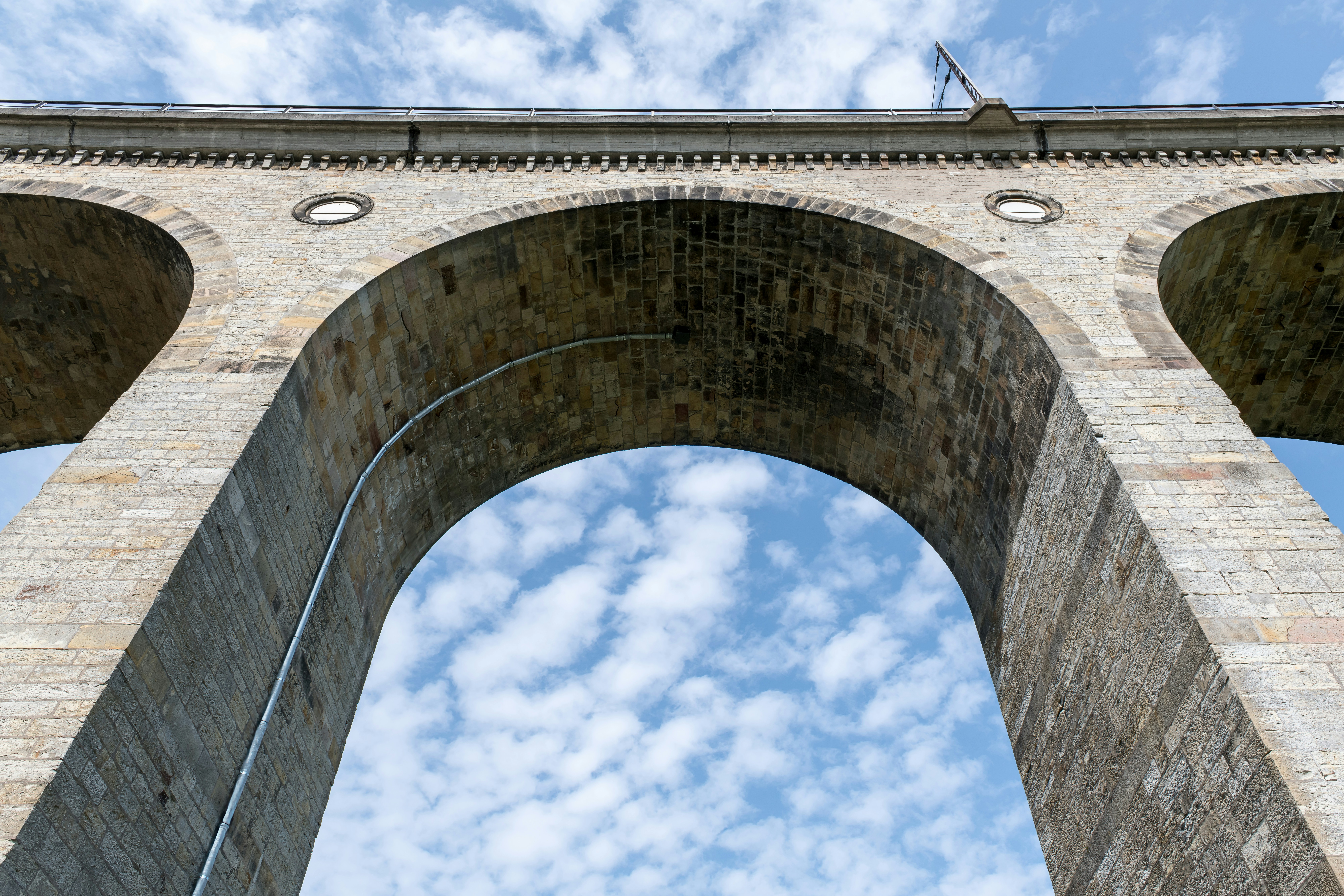 Apex of the Arch: Skyward Span in Weathered Stone
