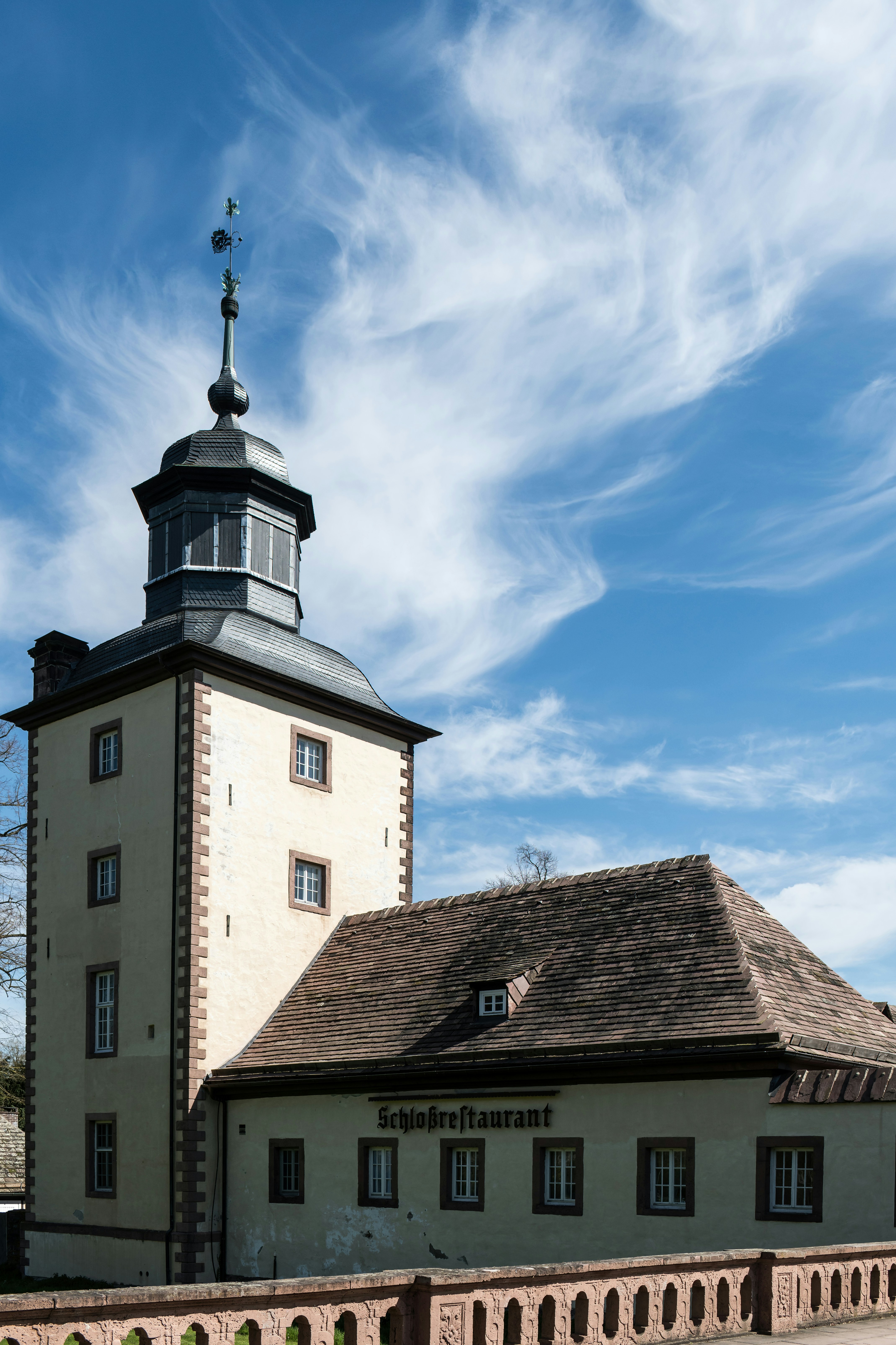 Towering Heritage: A Clocktower Rising Over a Quiet Bavarian Inn