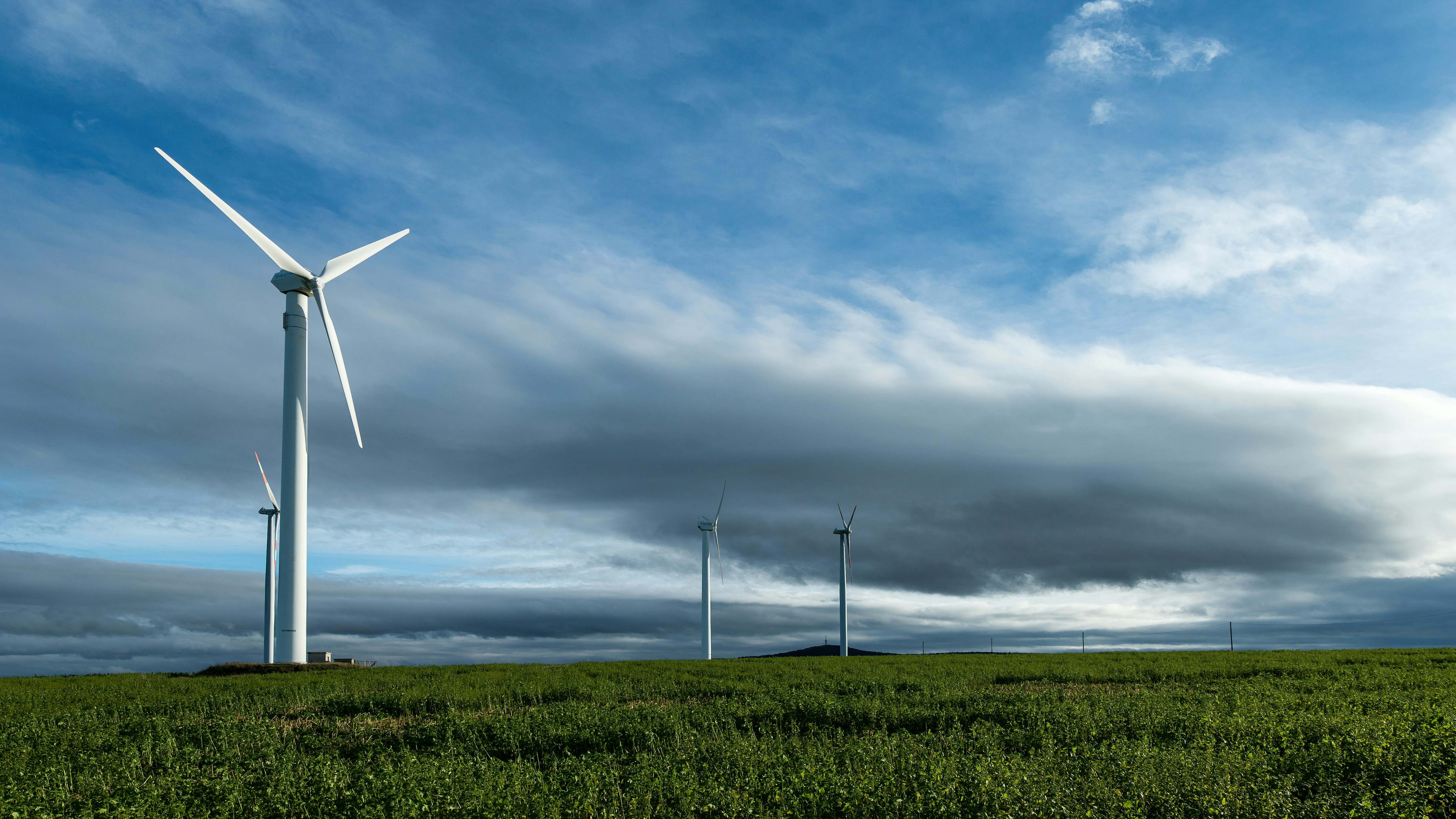 Whispering Giants: Wind Turbines Under a Looming Sky