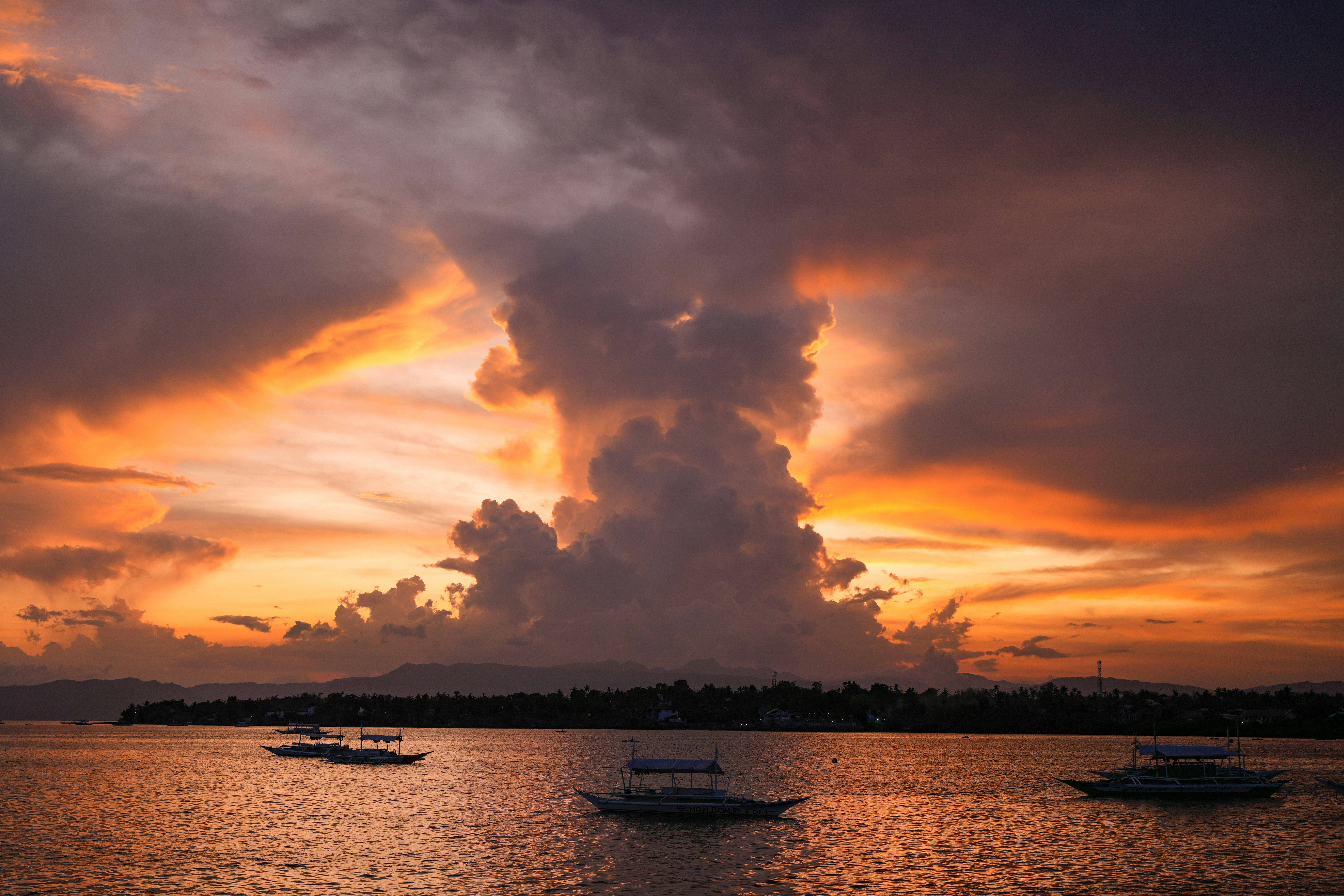 Horizon Ember: Boats in the Glowing Evening Sea