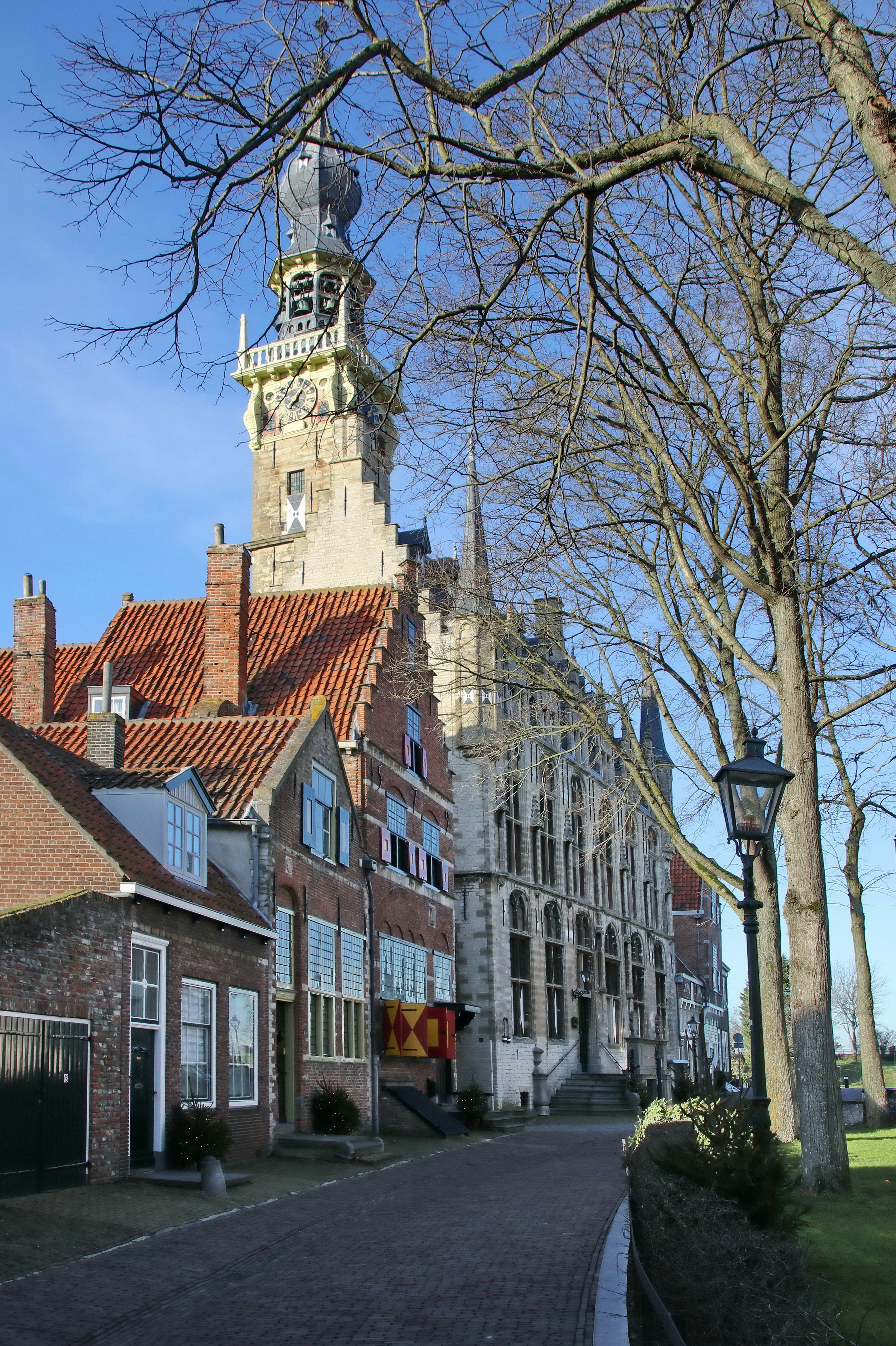 Towering Heritage: A Dutch Street with Clocktower and Gabled Facades