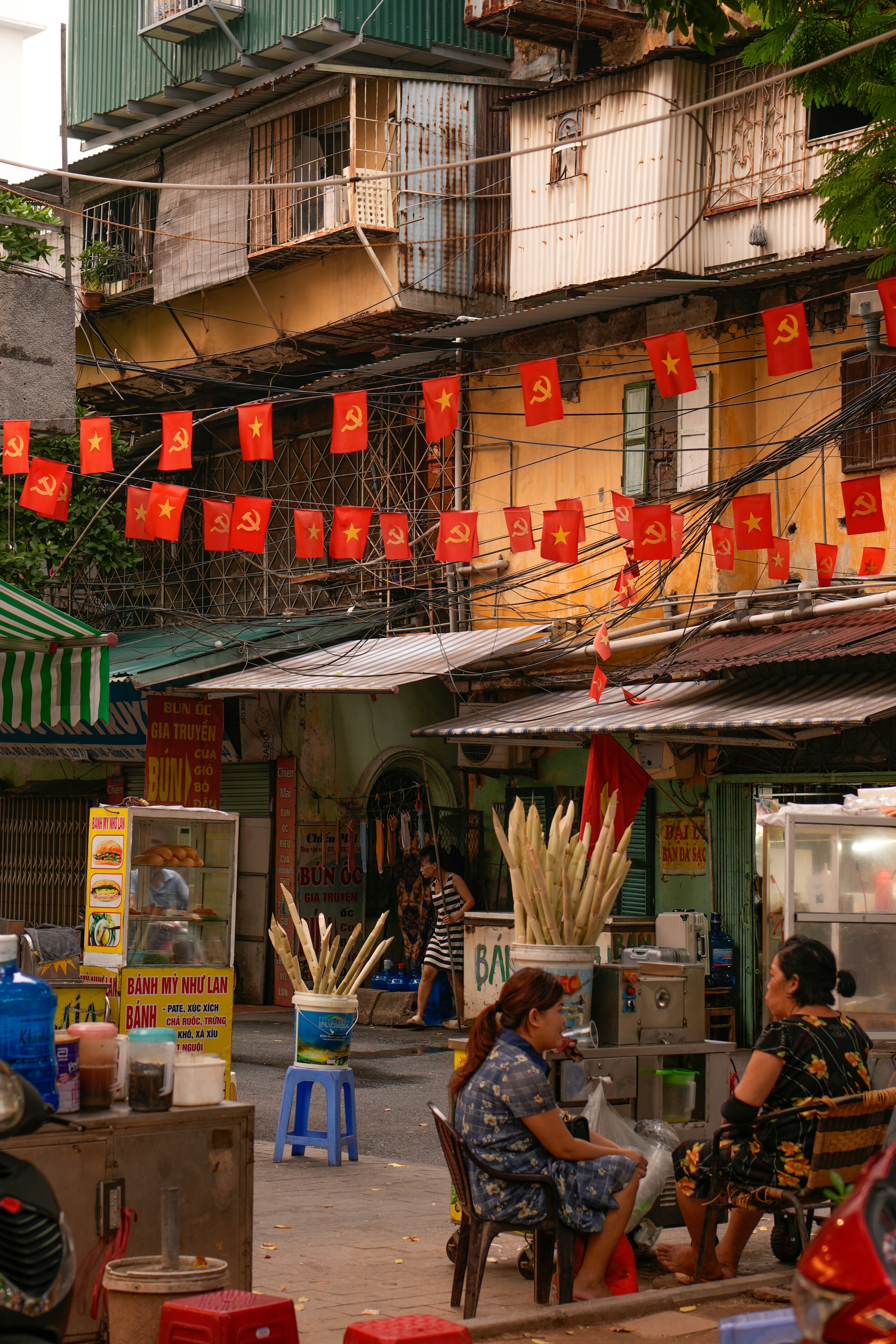 Market Alley Under Red Flags and Warm Sun