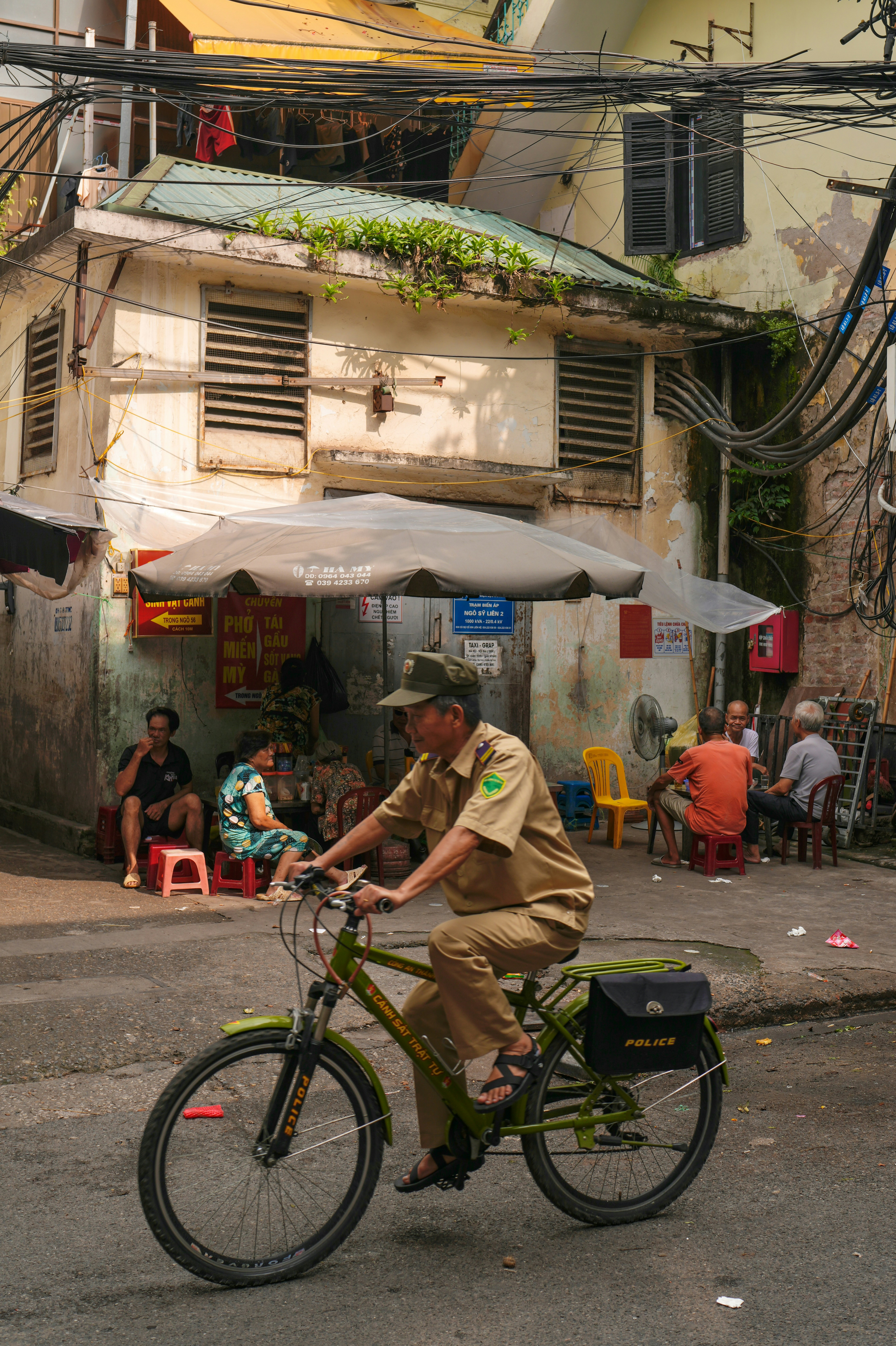 Midday Routine: A Vietnam Street Scene with a Policing Bicycle
