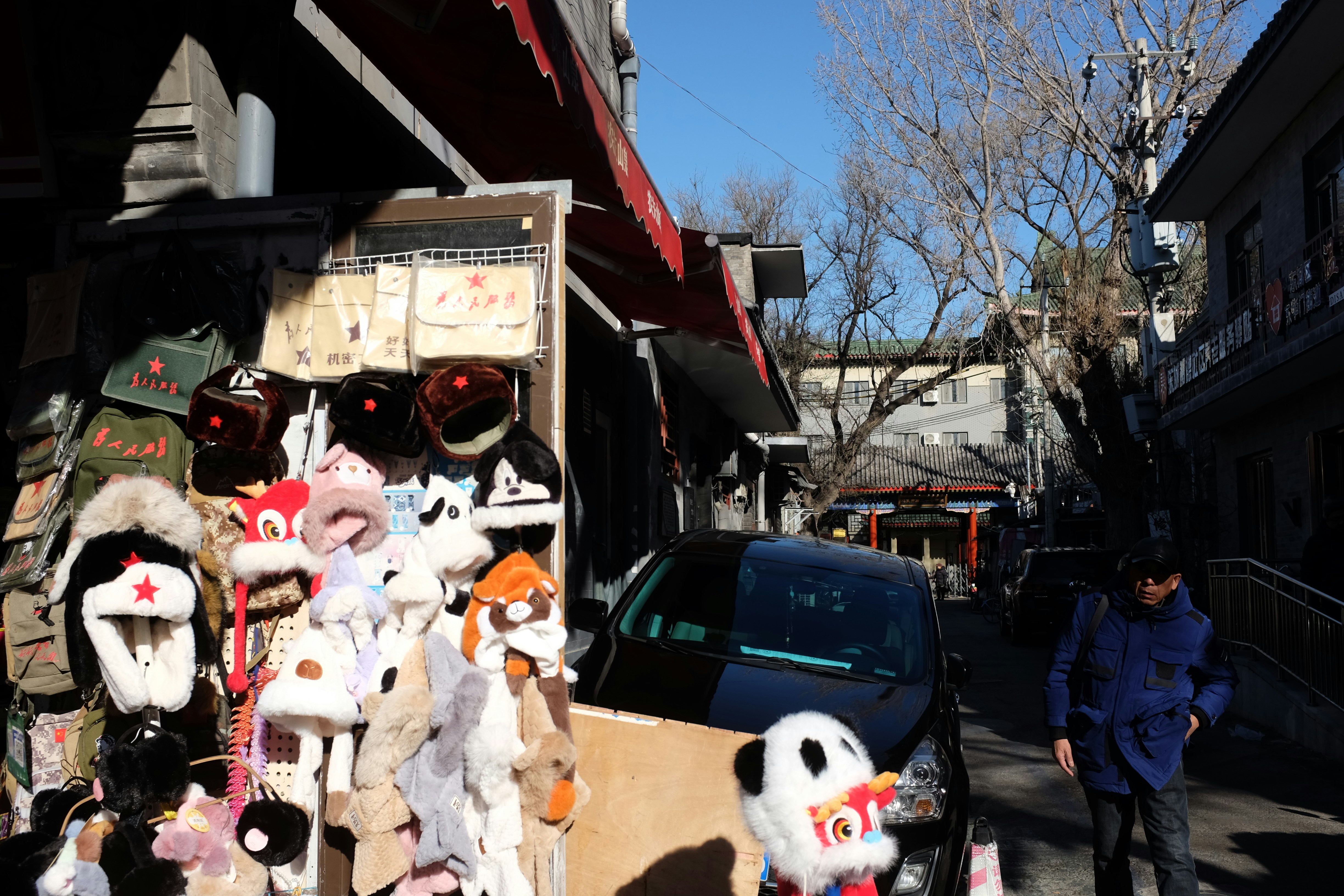 Street Snapshot: Plush Parade and Quiet Vehicle in a Busy Market