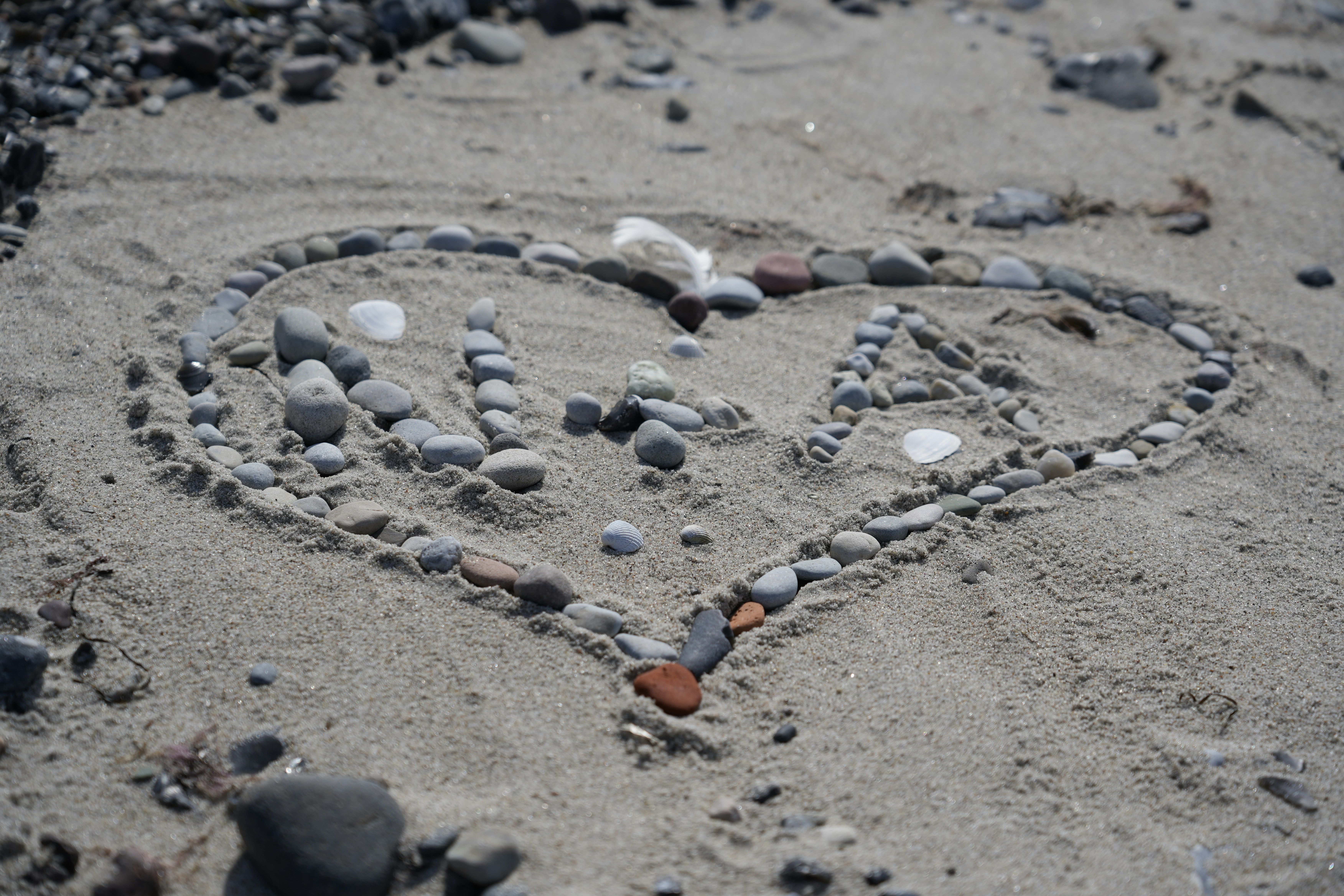 Pebble Mosaic Heart on Sandy Shore