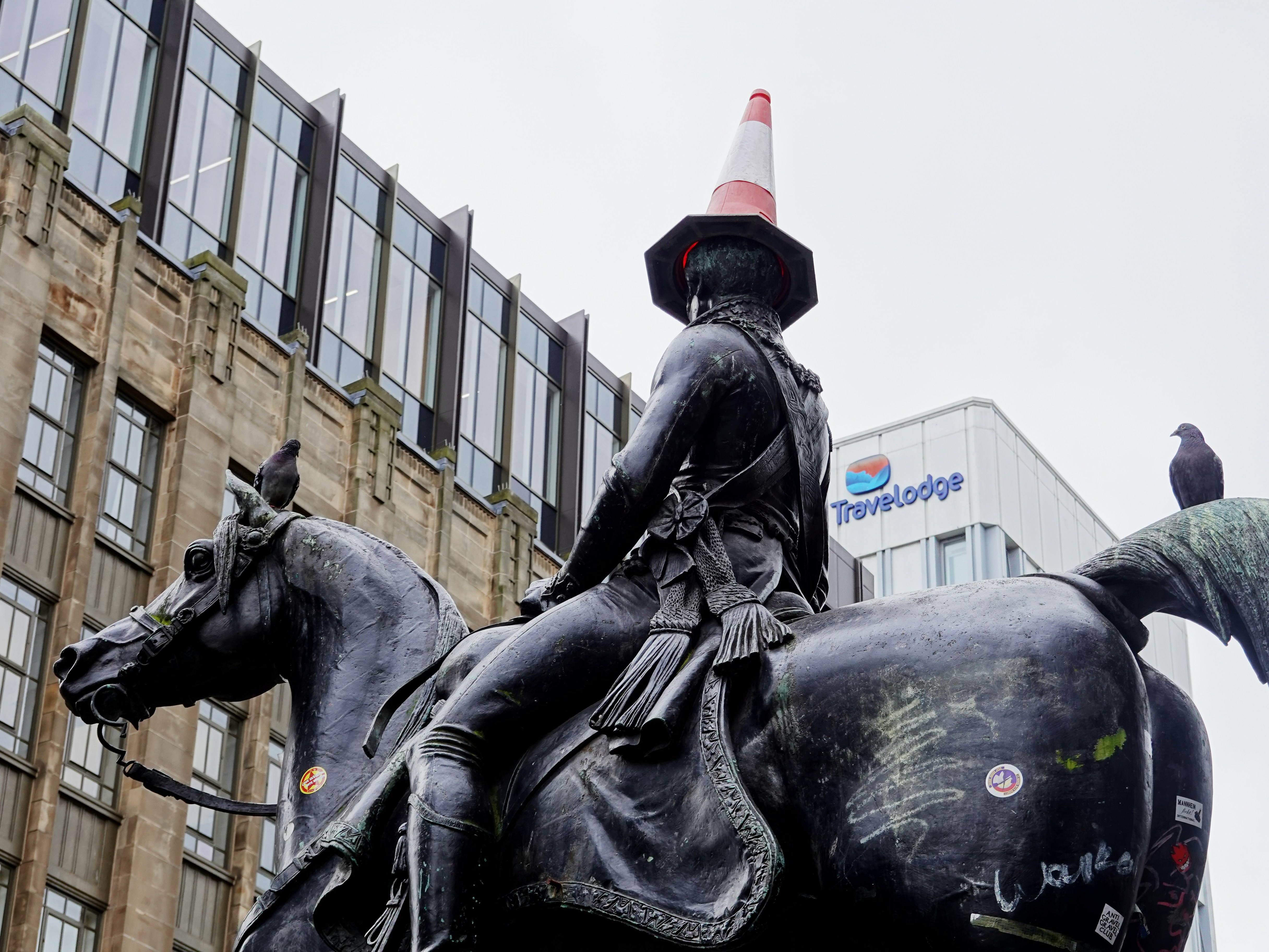 Equestrian Monument Amidst Urban Glass and Stone