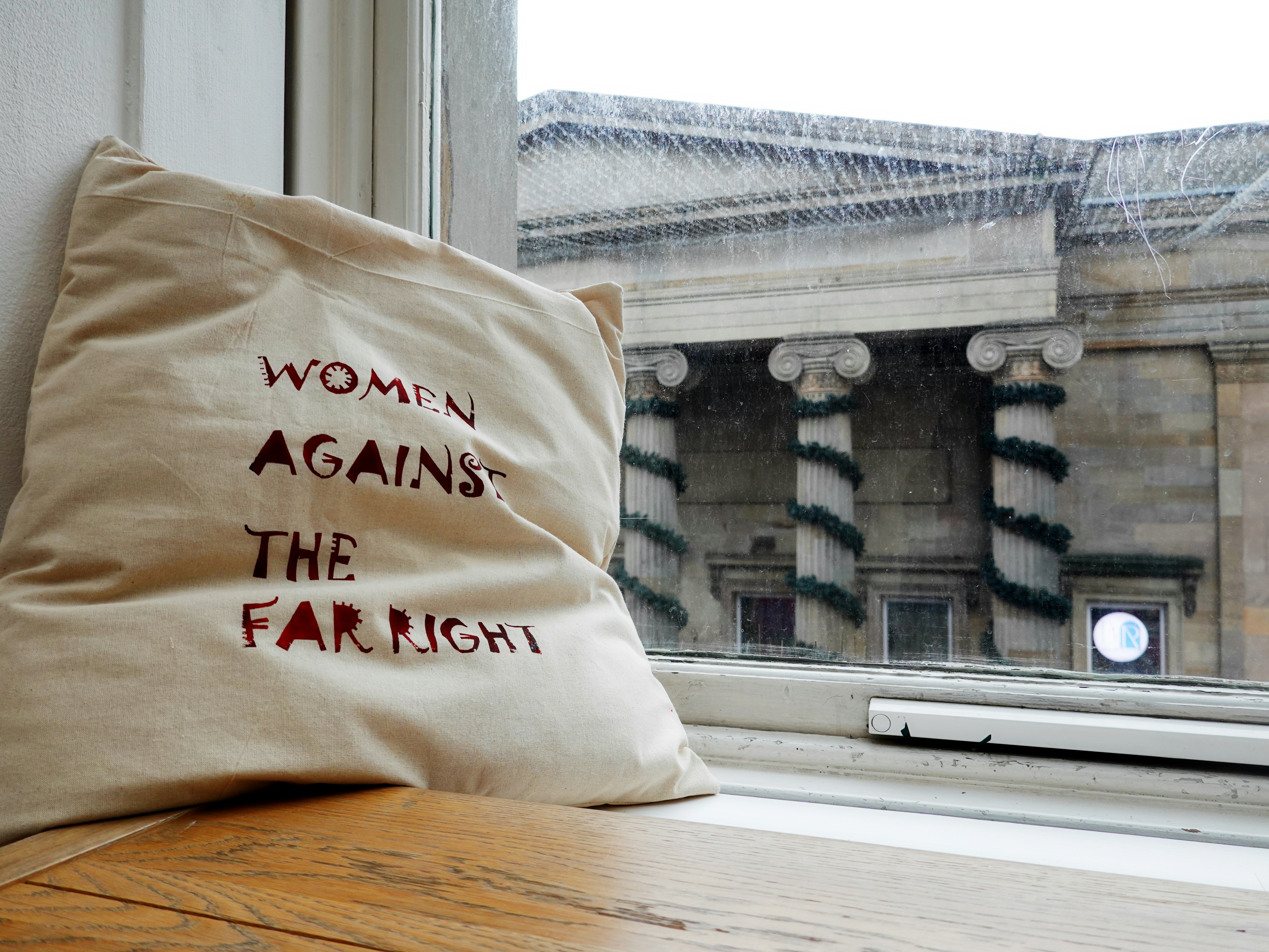 Pillow with Warped Text by Windowsill
