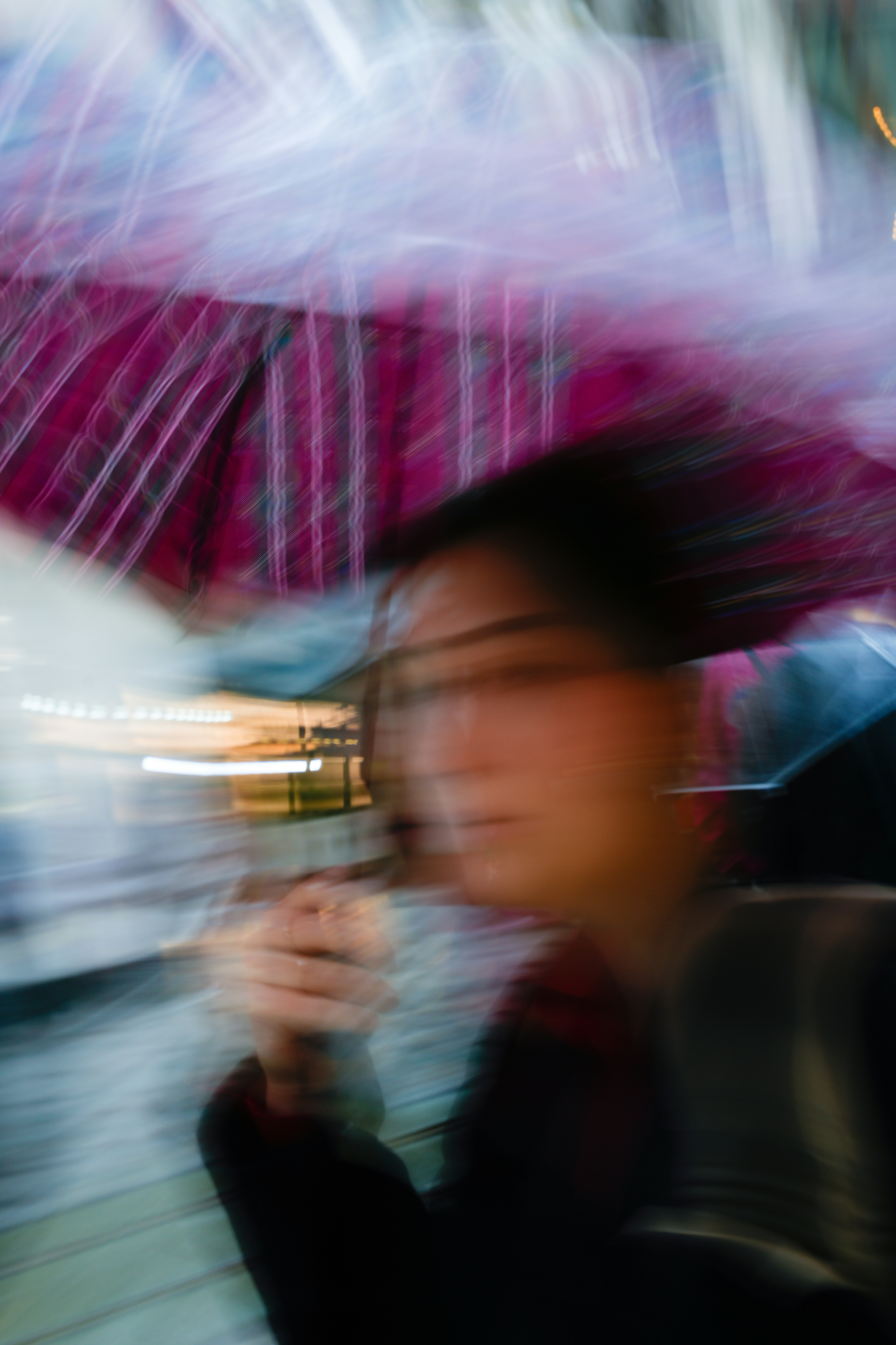 Blurry Umbrella Moment: A City Street in Motion