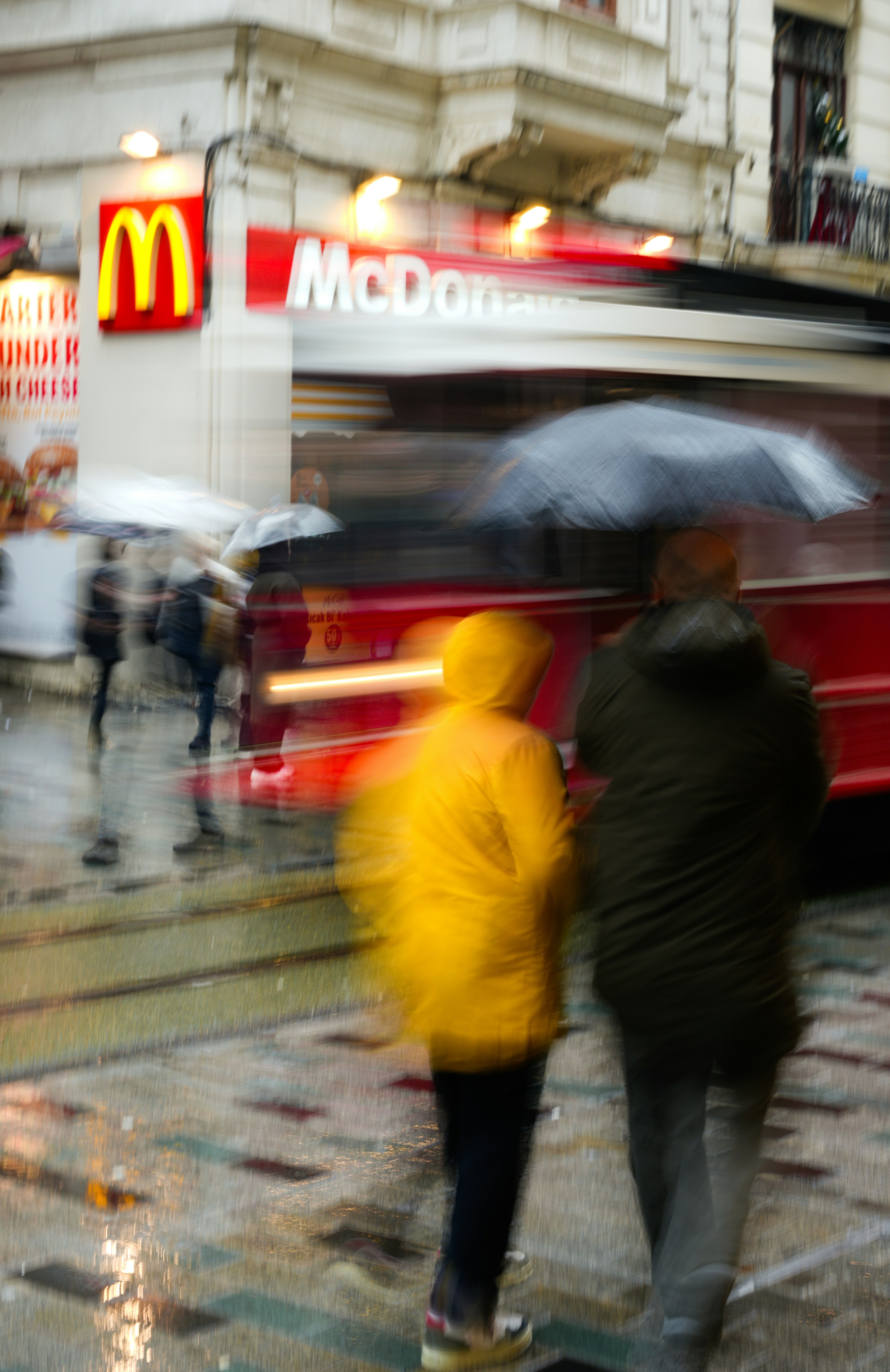 Blurred City Pulse: A Yellow Hood and a Swirling Bus