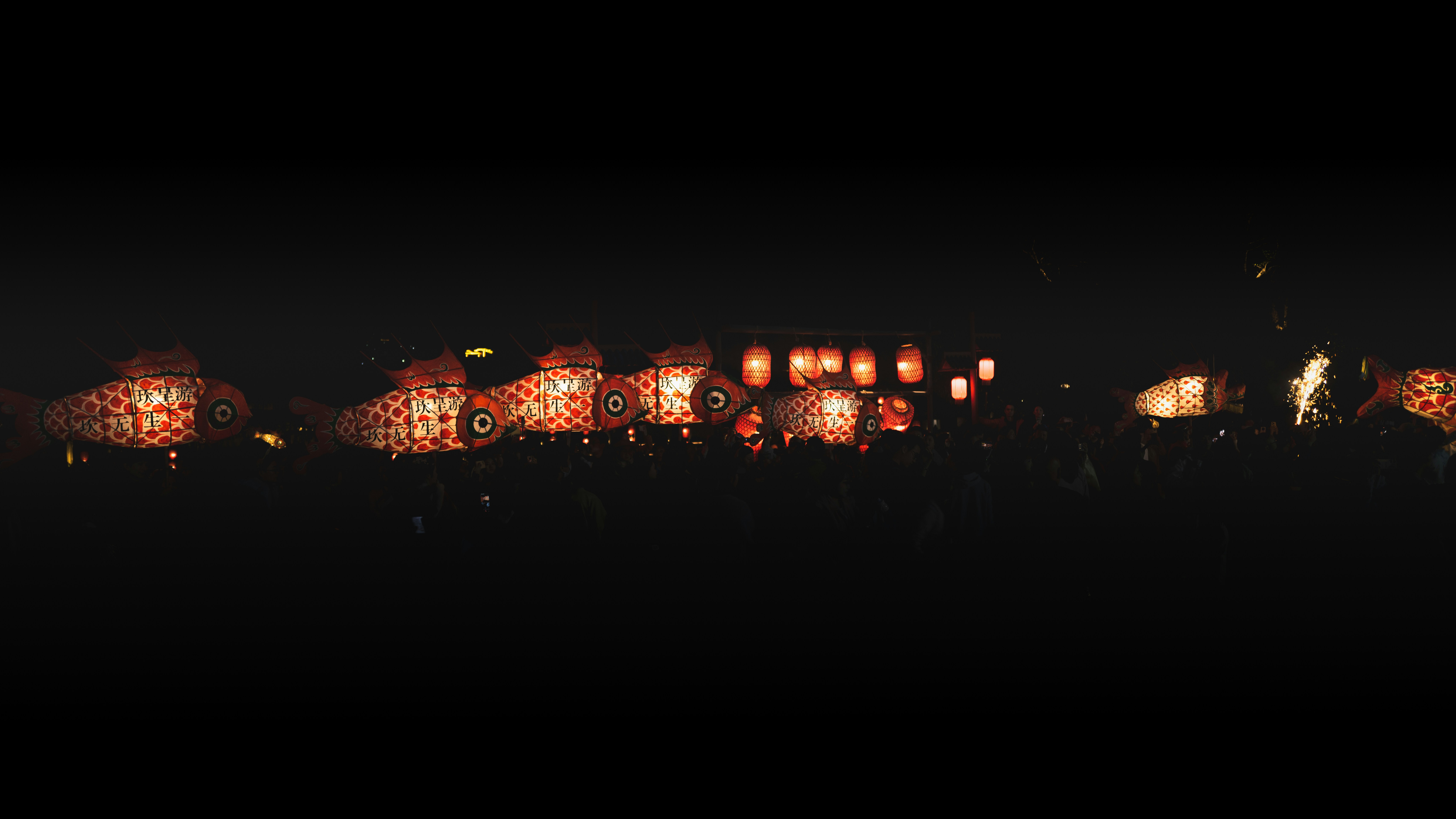 Lantern-lit Carvings float through a midnight procession