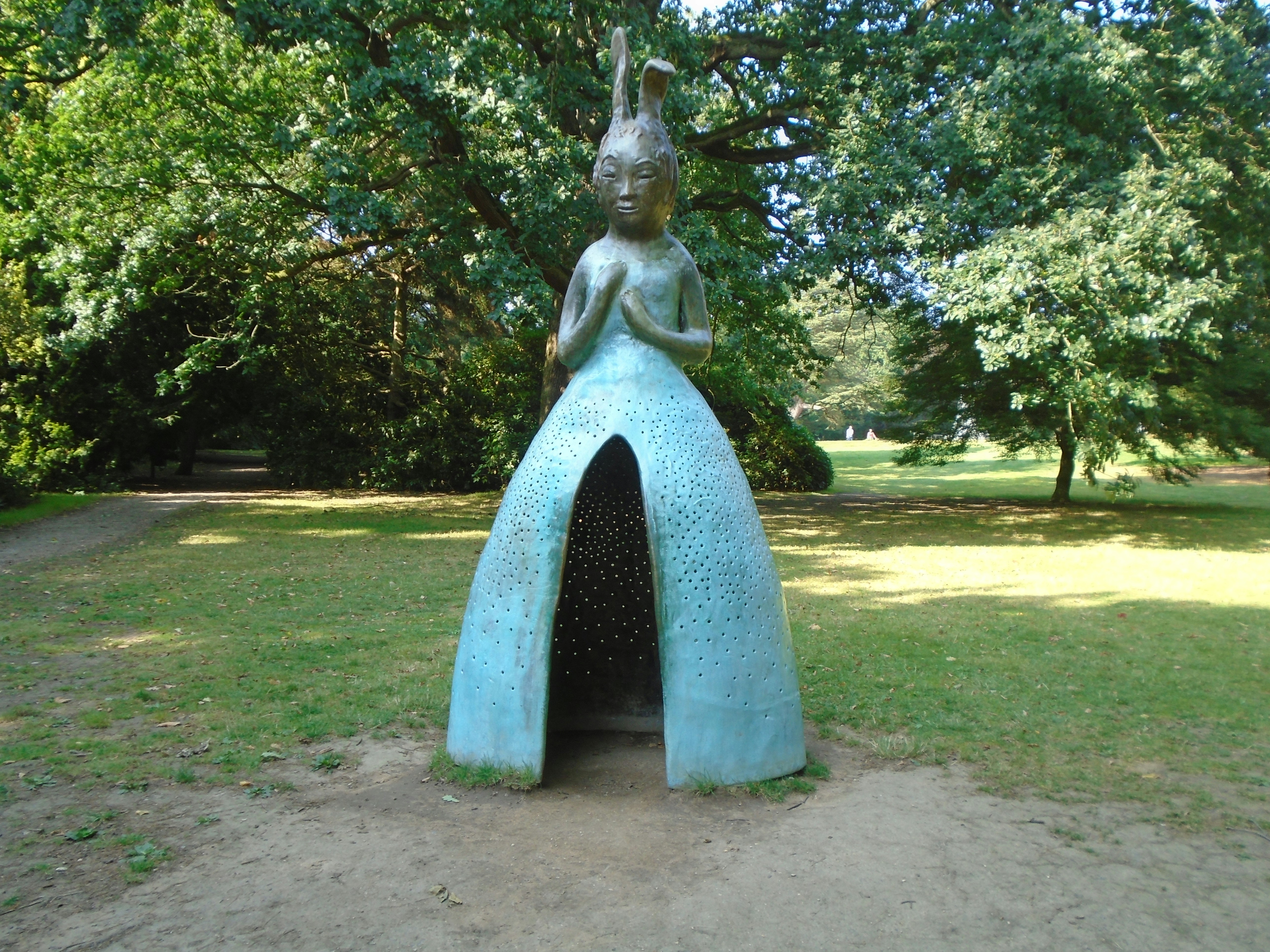 Bent-hipped Figure in a Teal Shelter: A Quiet Park Shrine