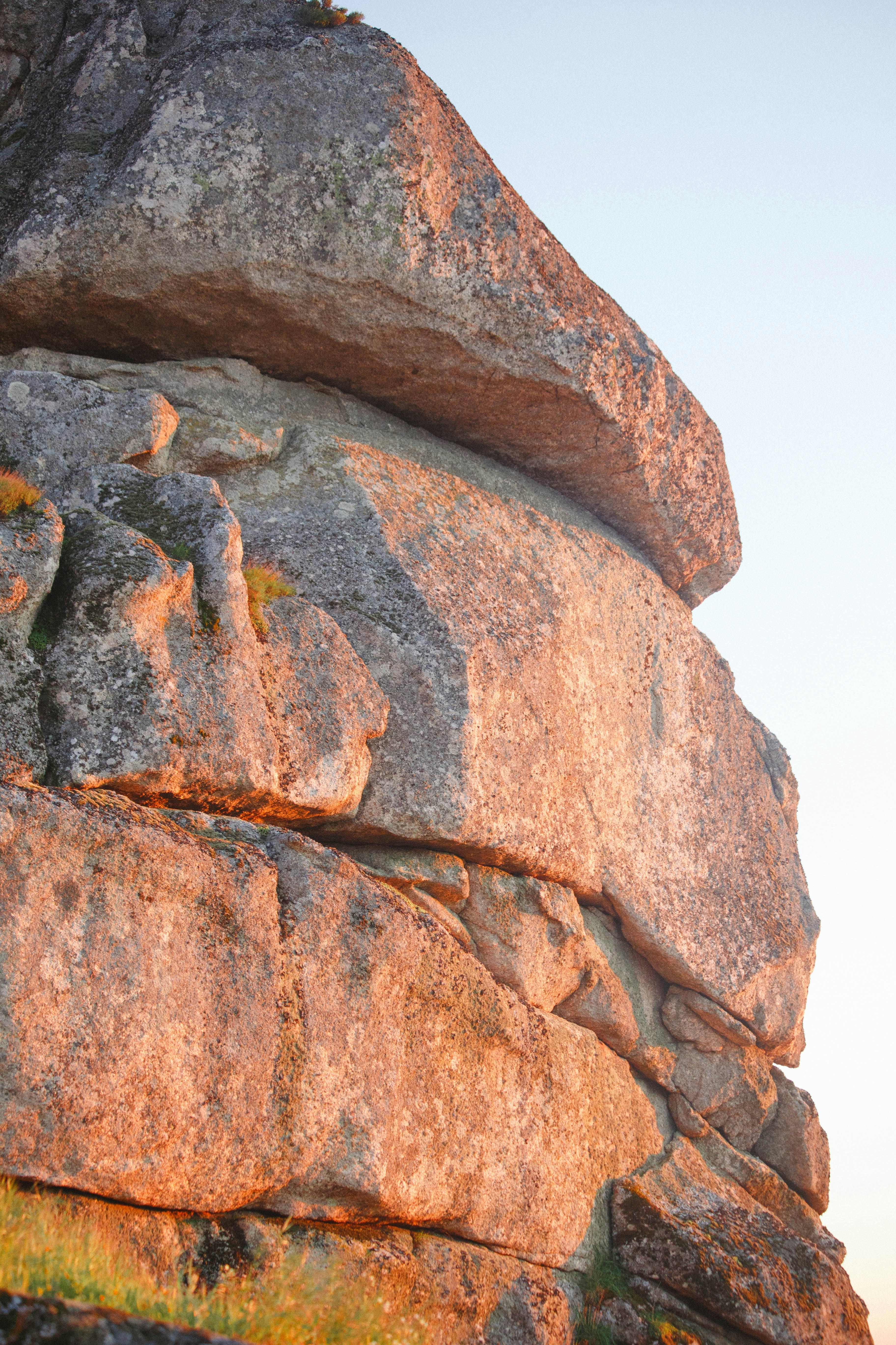 Sunlit Strata: A Mossy Clifftop Window in Warm Evening Light