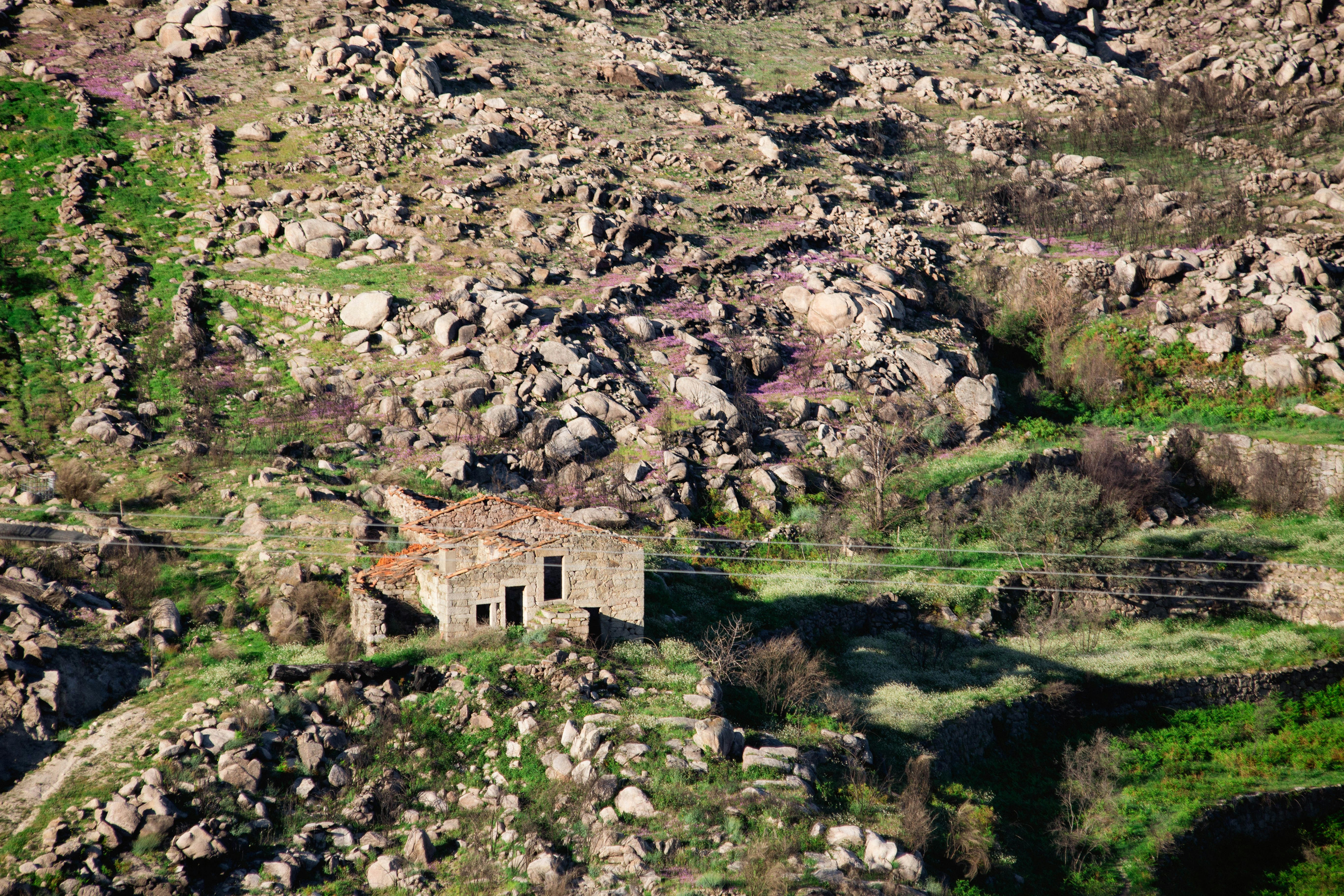 Stone Cabin in a Rugged Green Valley
