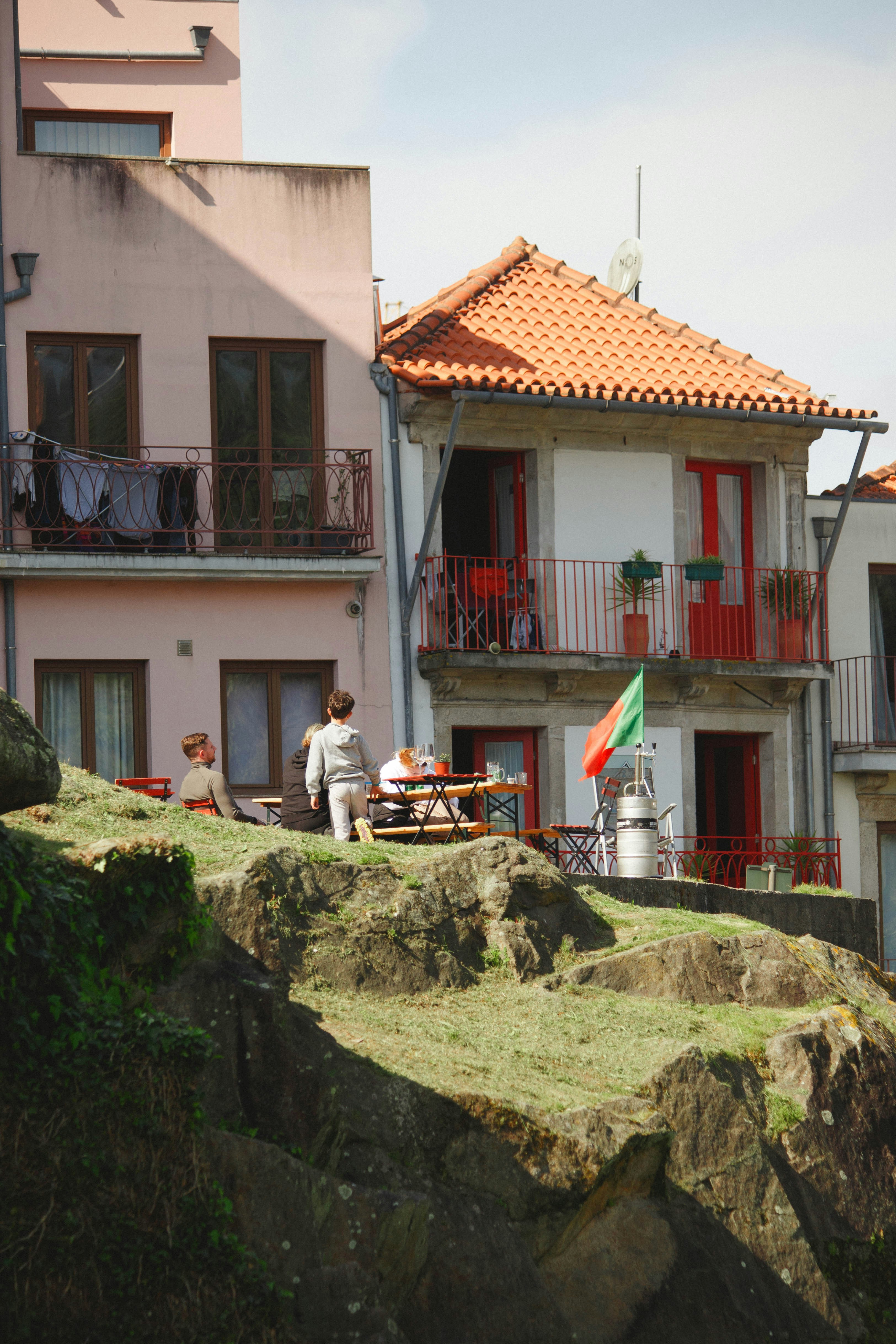 Italian Clifftop Terrace: A Quiet Gathering by the Red Door