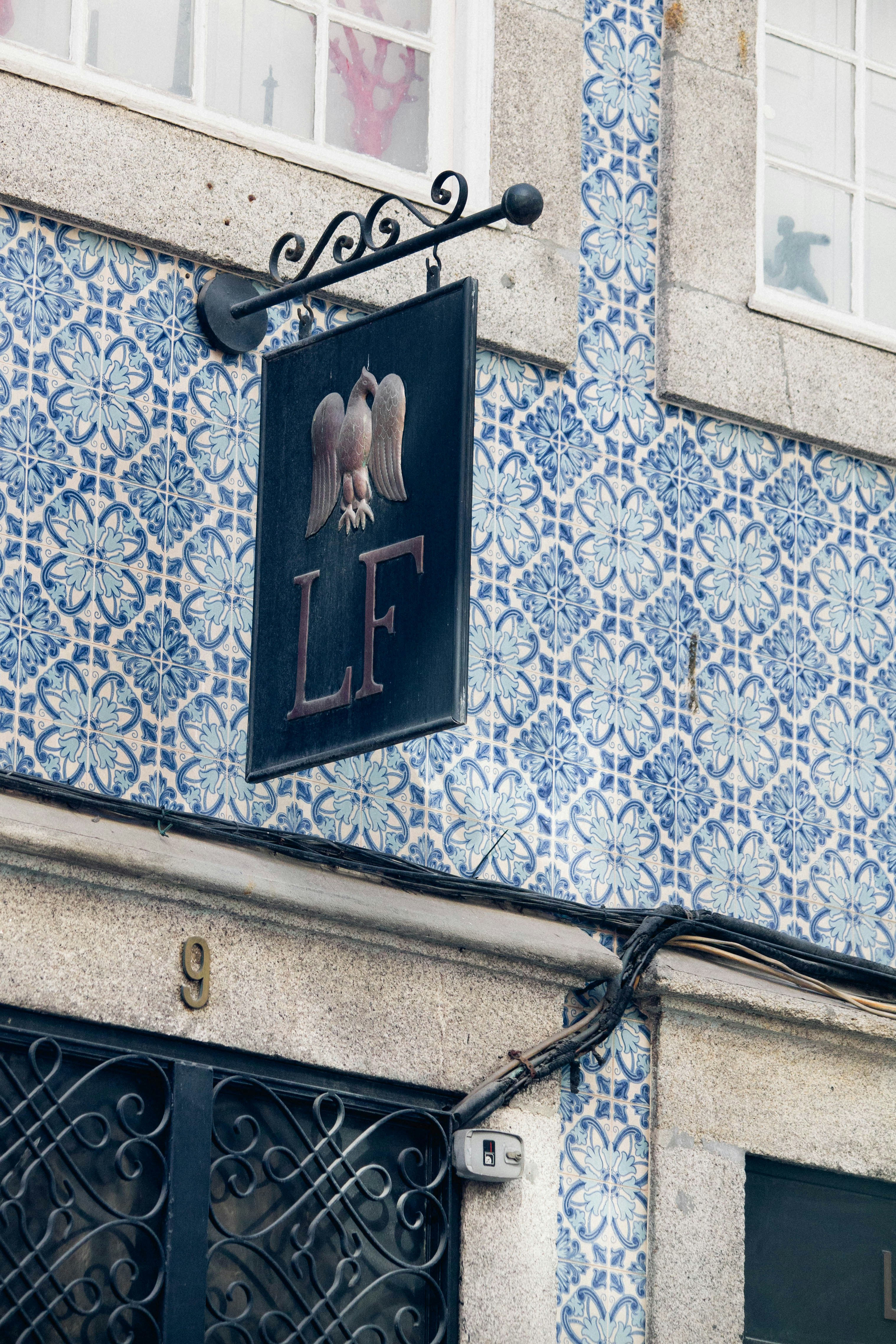 Blue Tiles and Signage: a Street-Level Detail of a Portuguese Café Facade