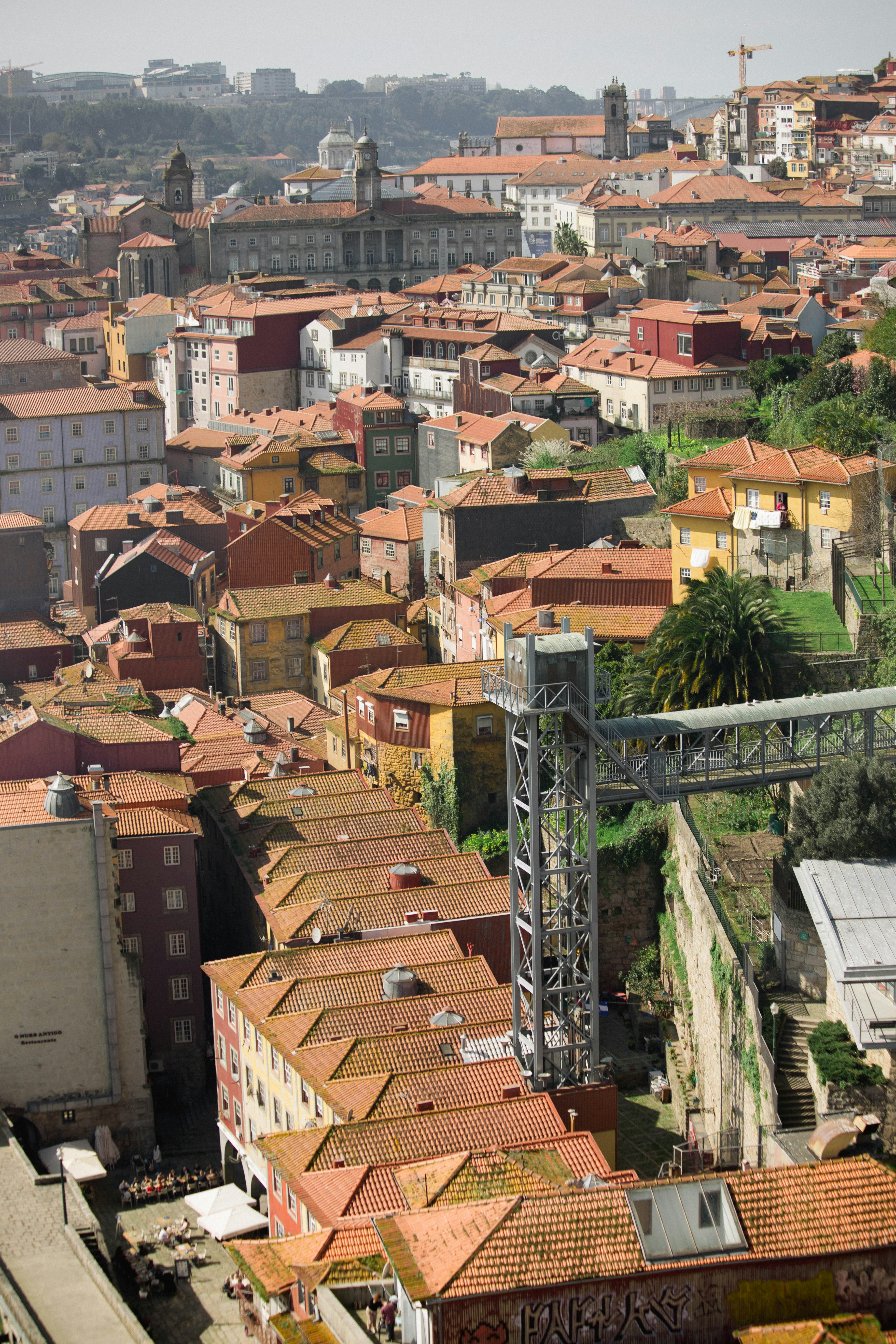Terraced hillside in the sun: a pastel cityscape crowned by red-tiled roofs