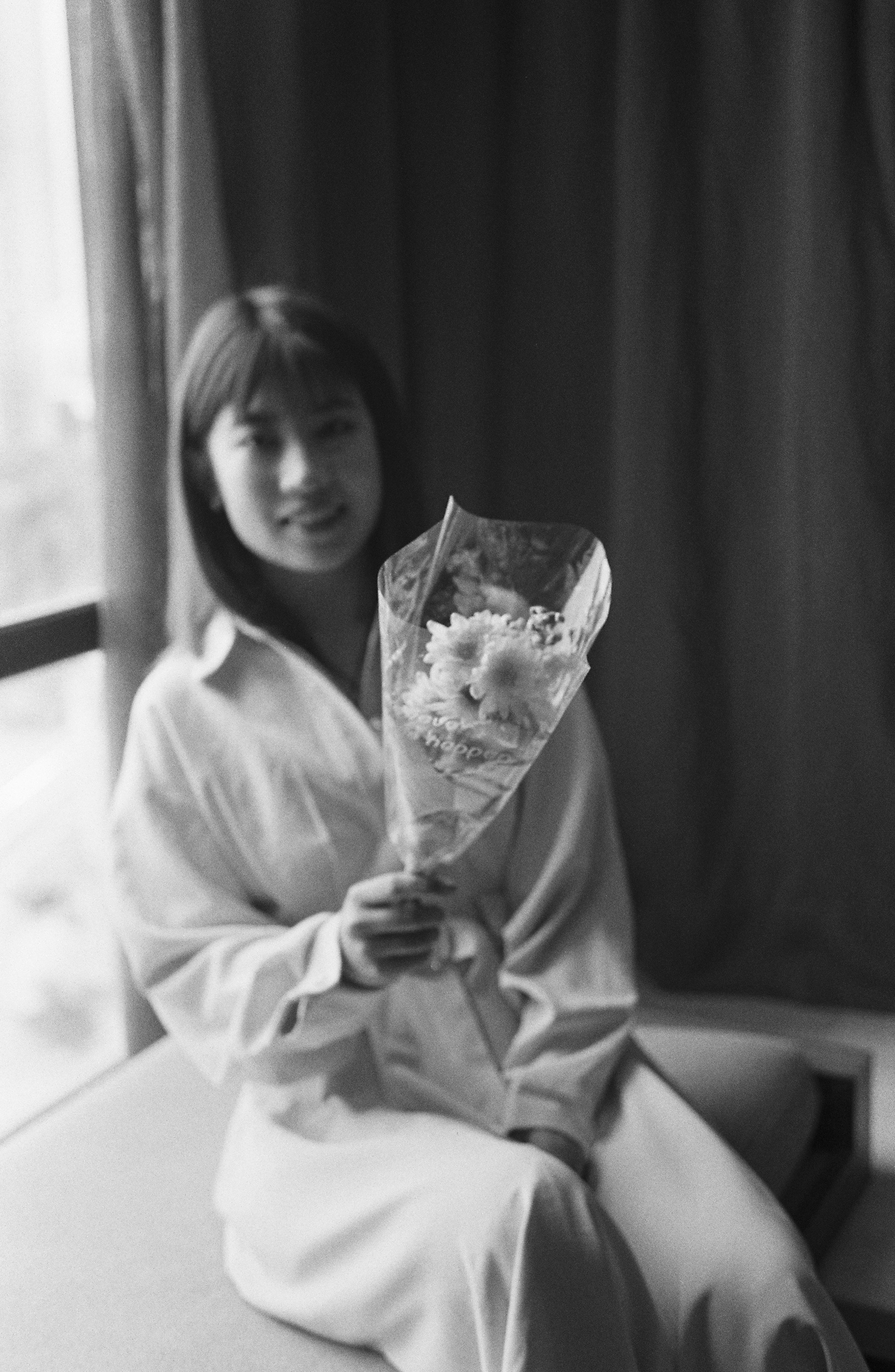 Flowered Moment: A Quiet Portrait in Soft Grayscale