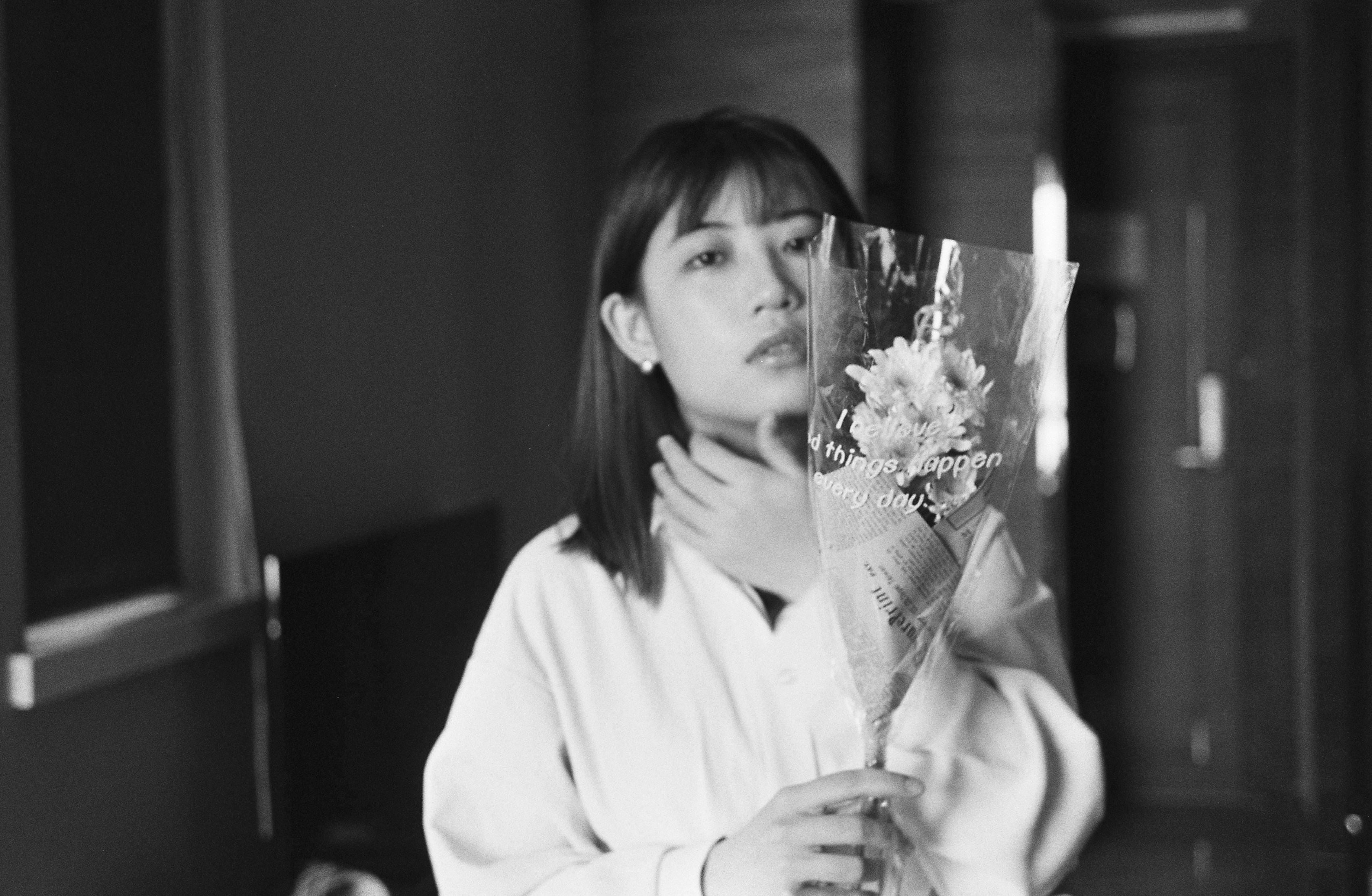 Bouquet in the Spotlight: Quiet Pose of a Young Woman