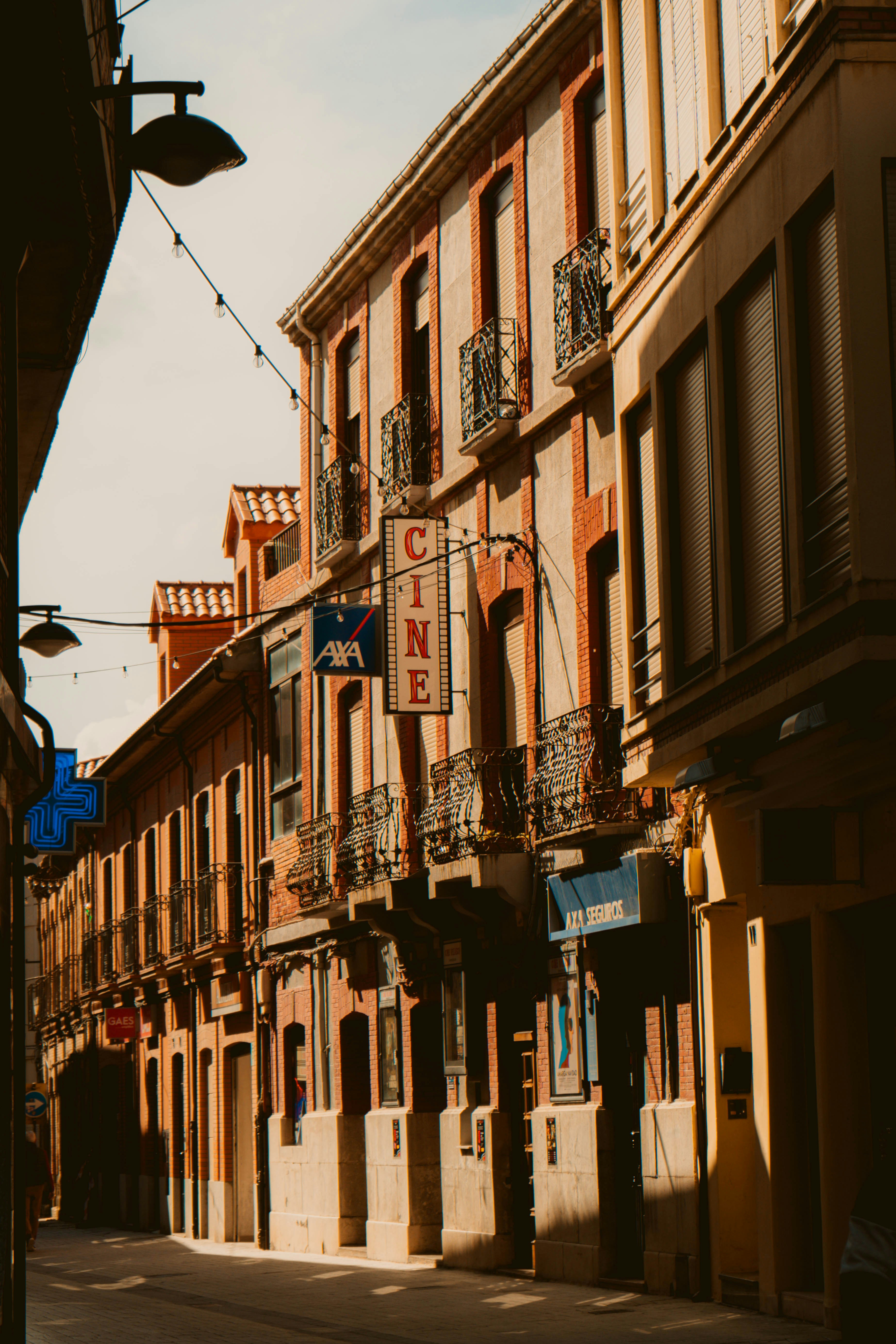 Sunlit Calle of Brick and Iron
