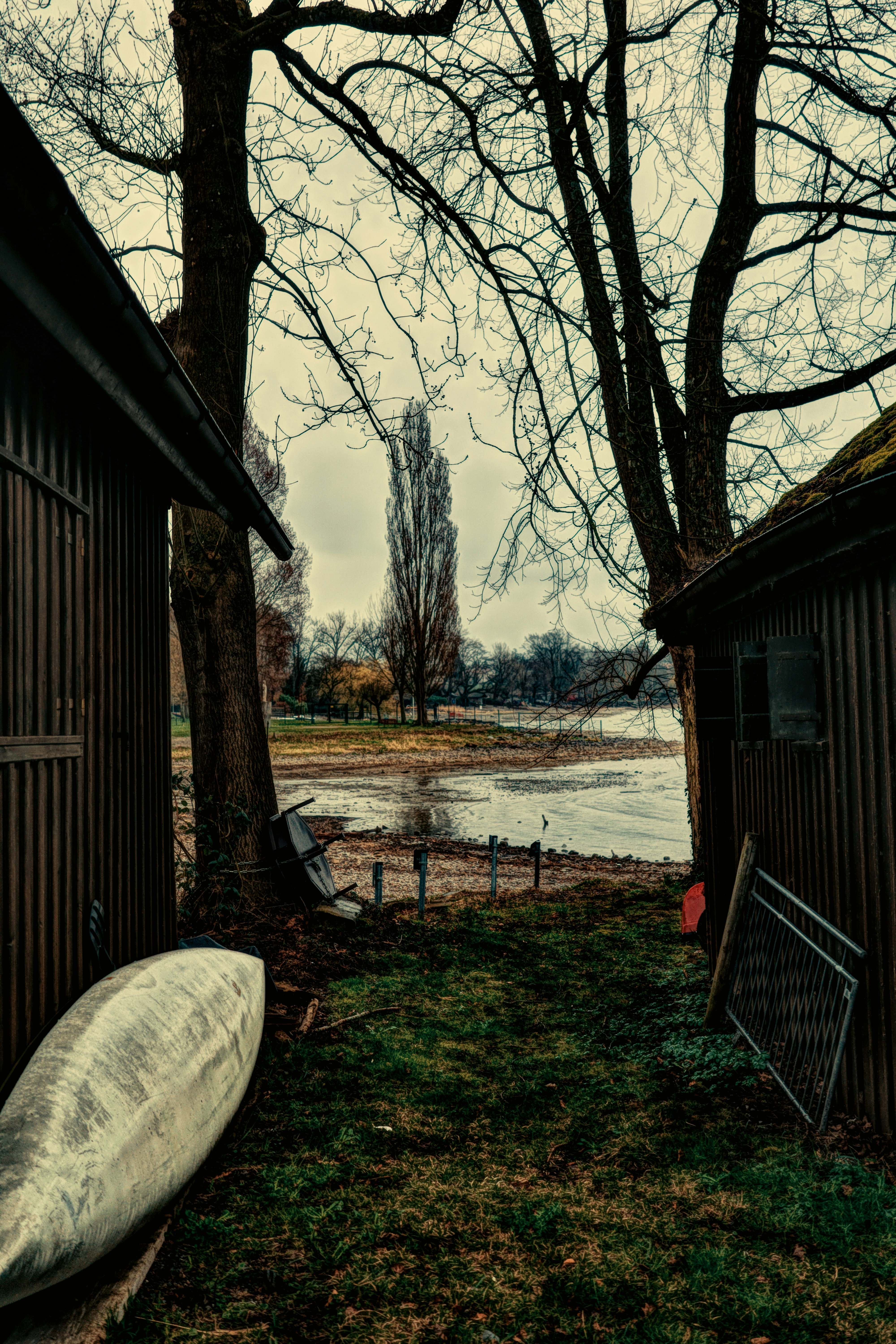 Between Sheds and the Riverbank: A Quiet Buttressed Pathway