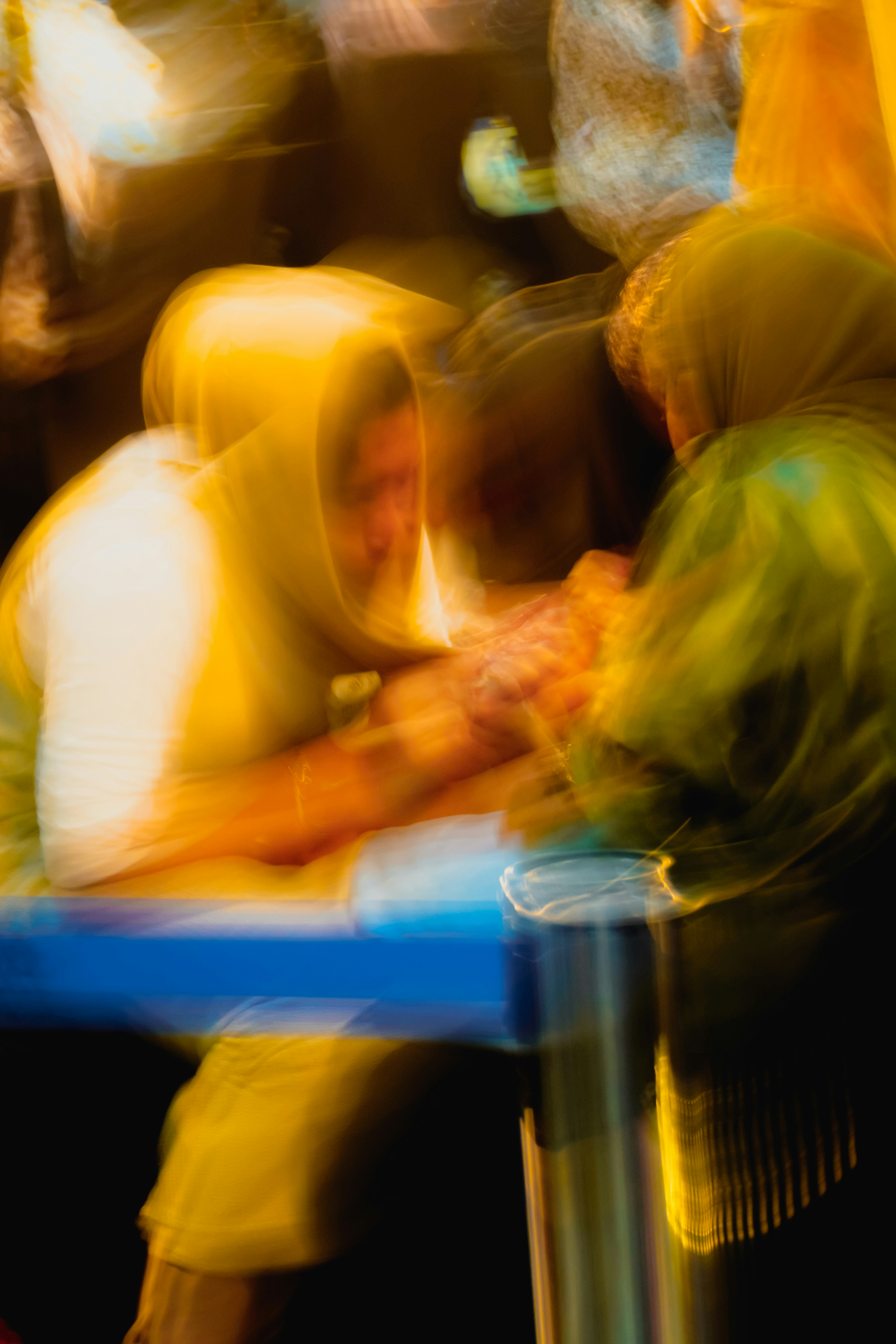 Hushed Exchange in a Blurred Night Market