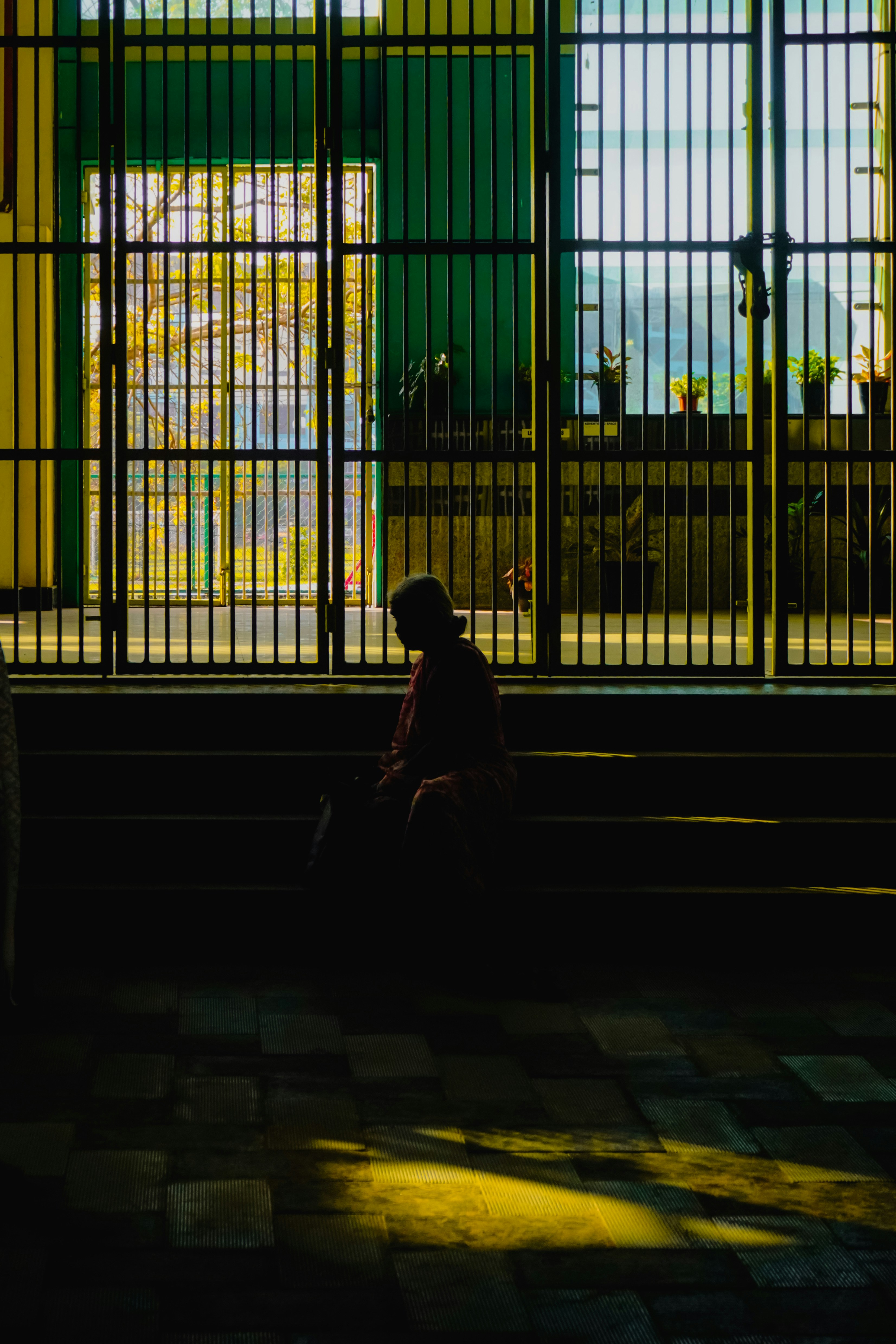 Silhouetted Figure Beneath Golden Barred Light