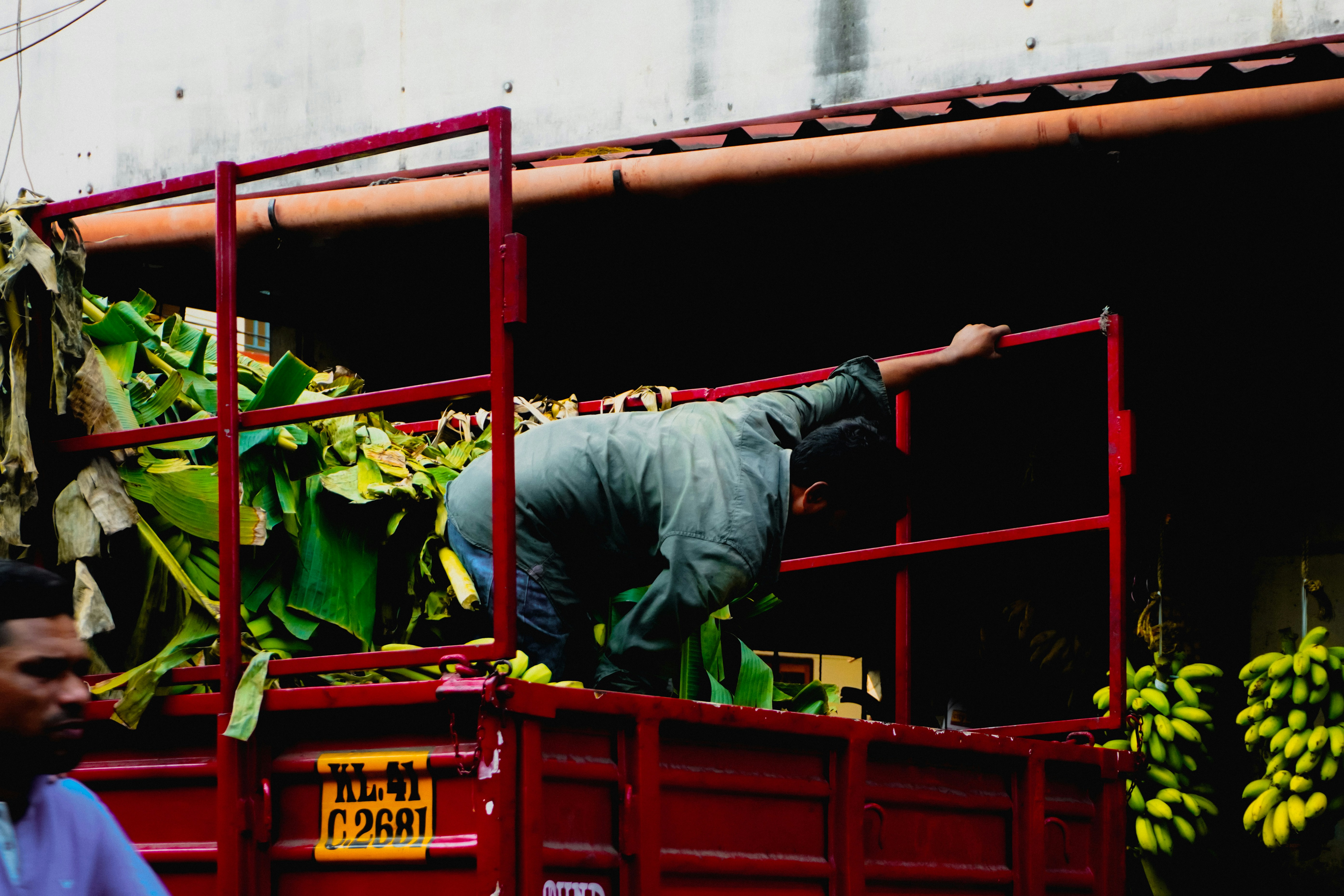 Worker Reaching into a Red Cargo Truck
