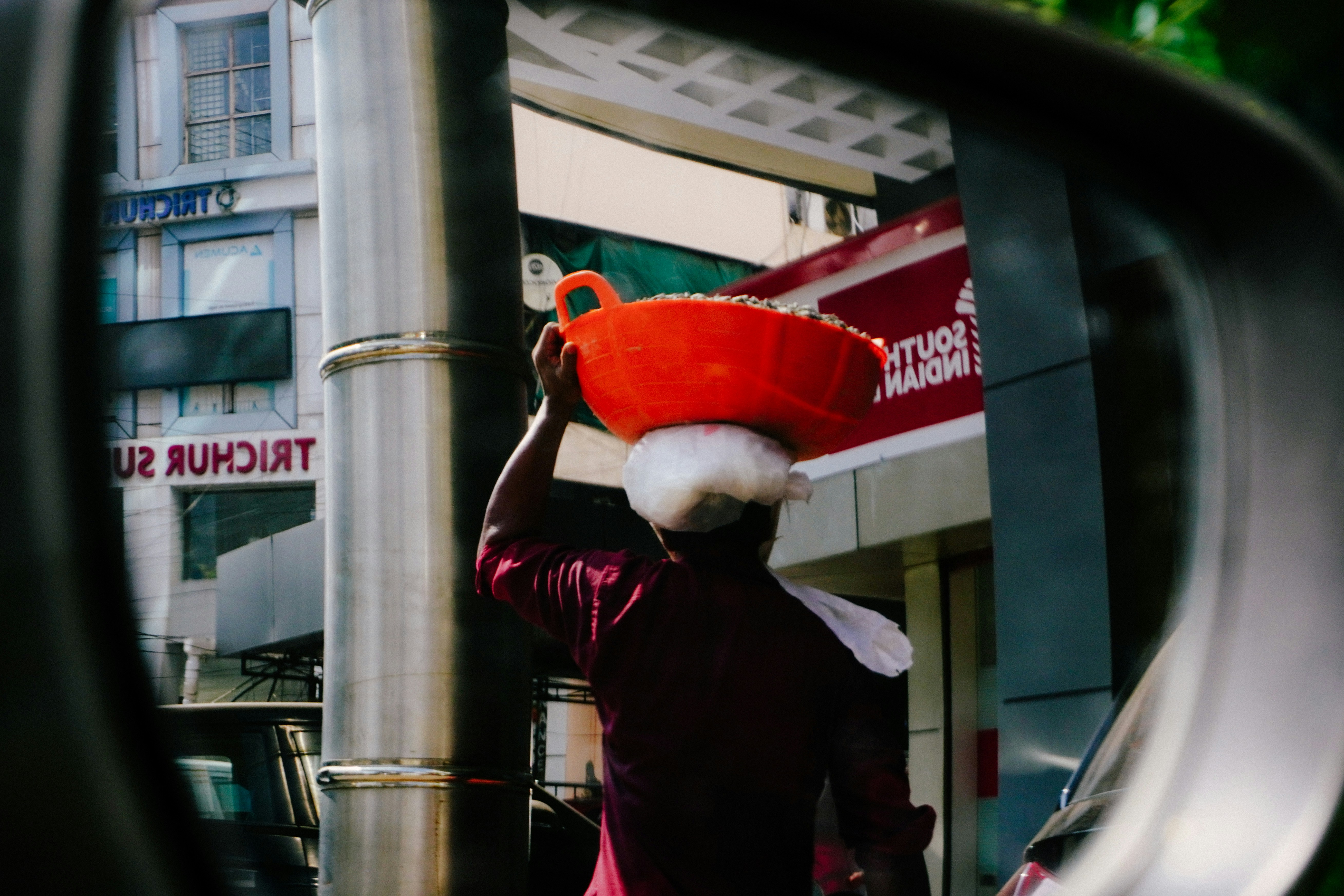 Basket of Bright Redins: Street Vendor Reflected in a Bicycle Mirror
