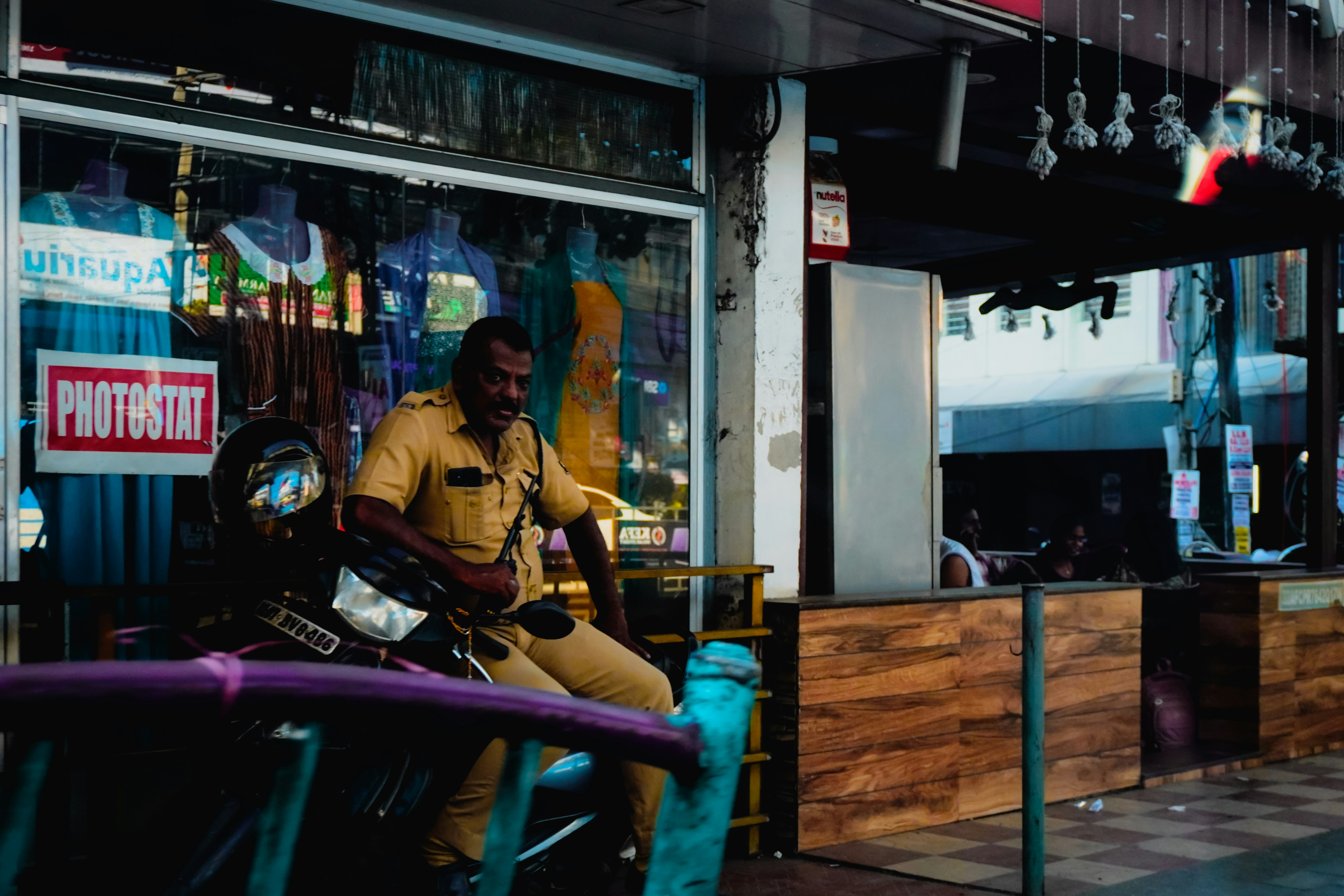 Police Officer in Front of Shopfront at Dusk
