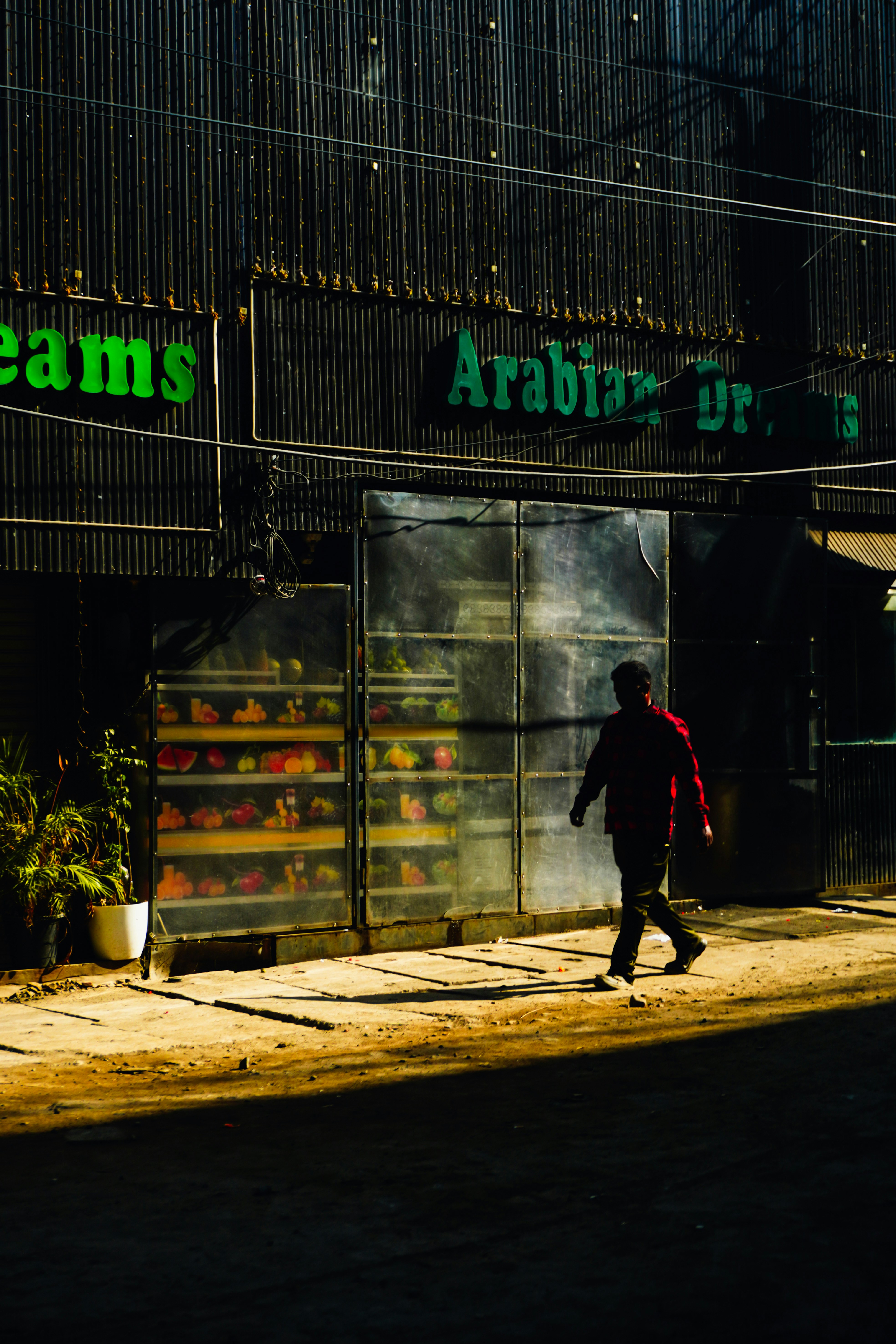 Neon Green Sign, Quiet Step, and Fruit Stand Under Rain-Touched Night