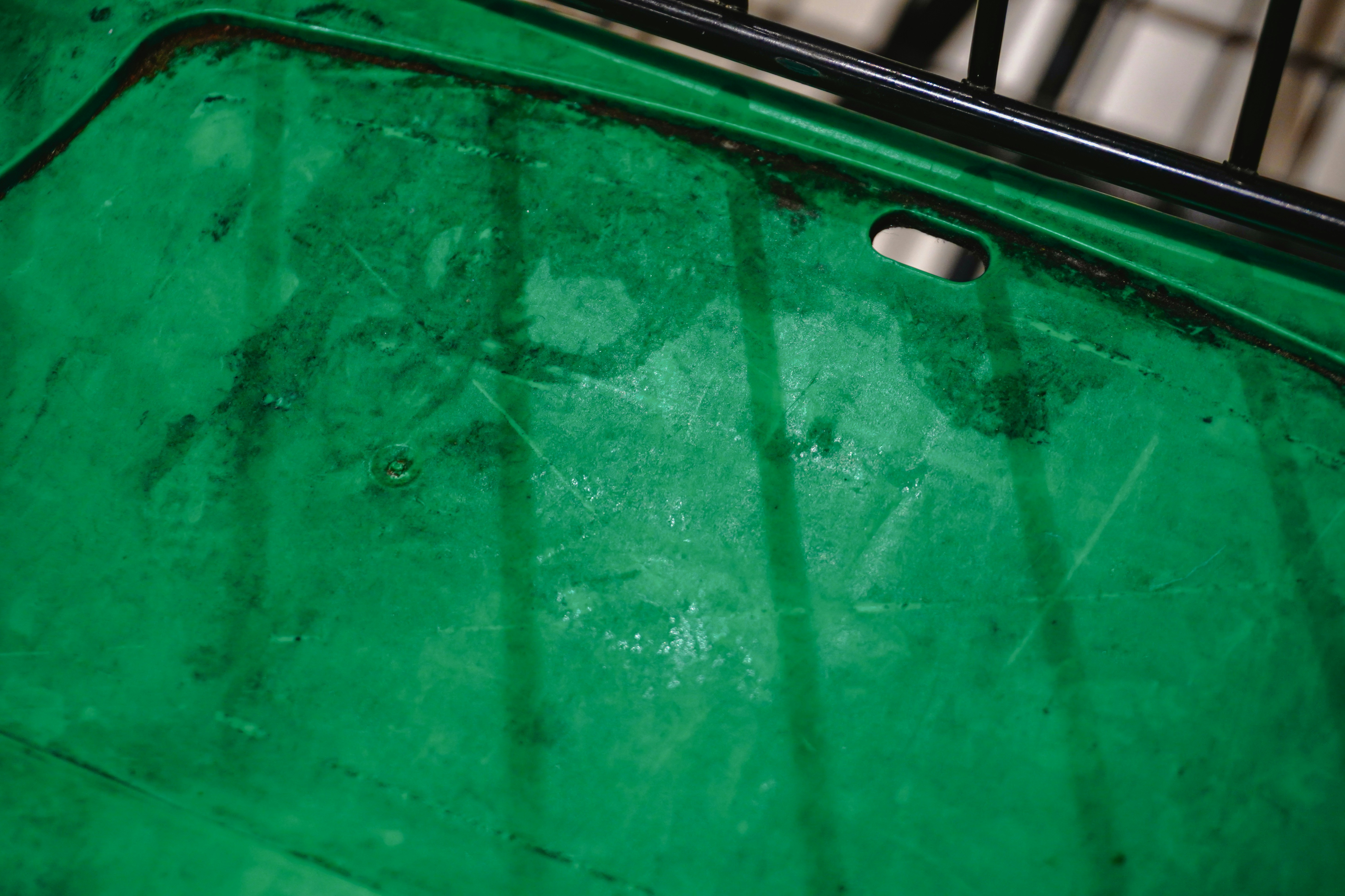 Grungy Green Surface with Subtle Reflections and Vent Hole
