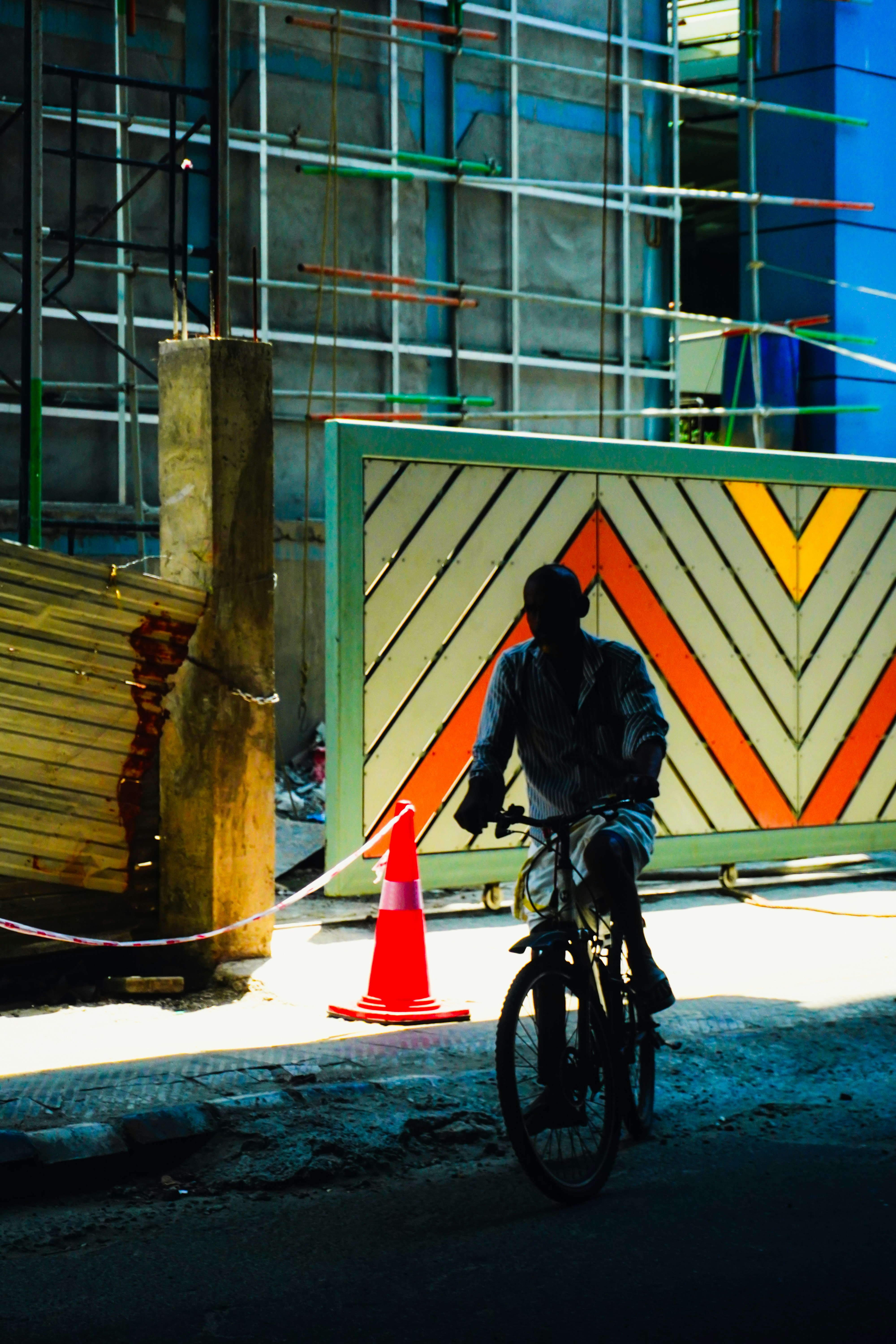 Shadow Rider at a Colorful Construction Gate