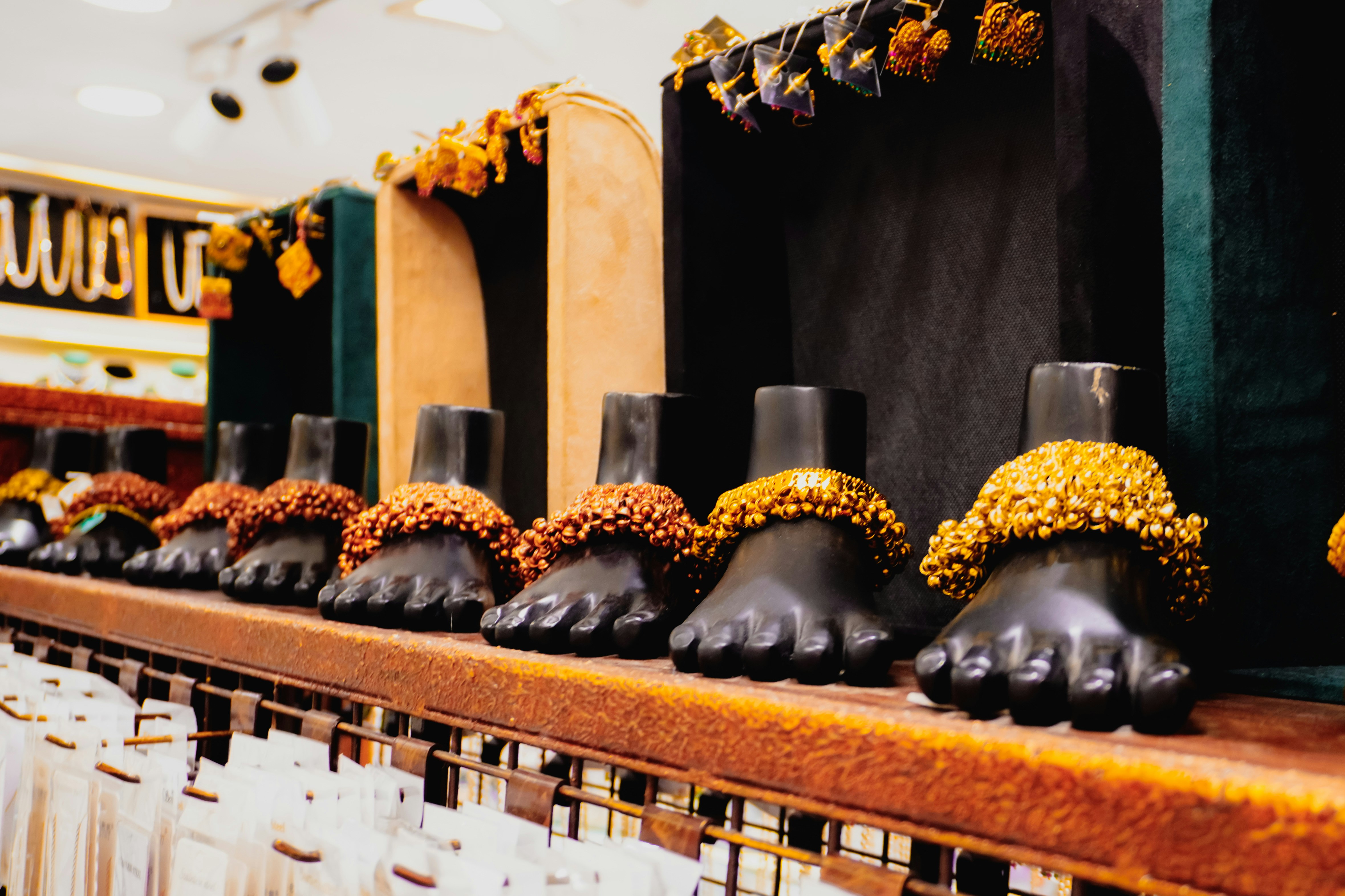 Golden Buds on Black Boots: A Row of Decorated Shoes Reaching the Aisle